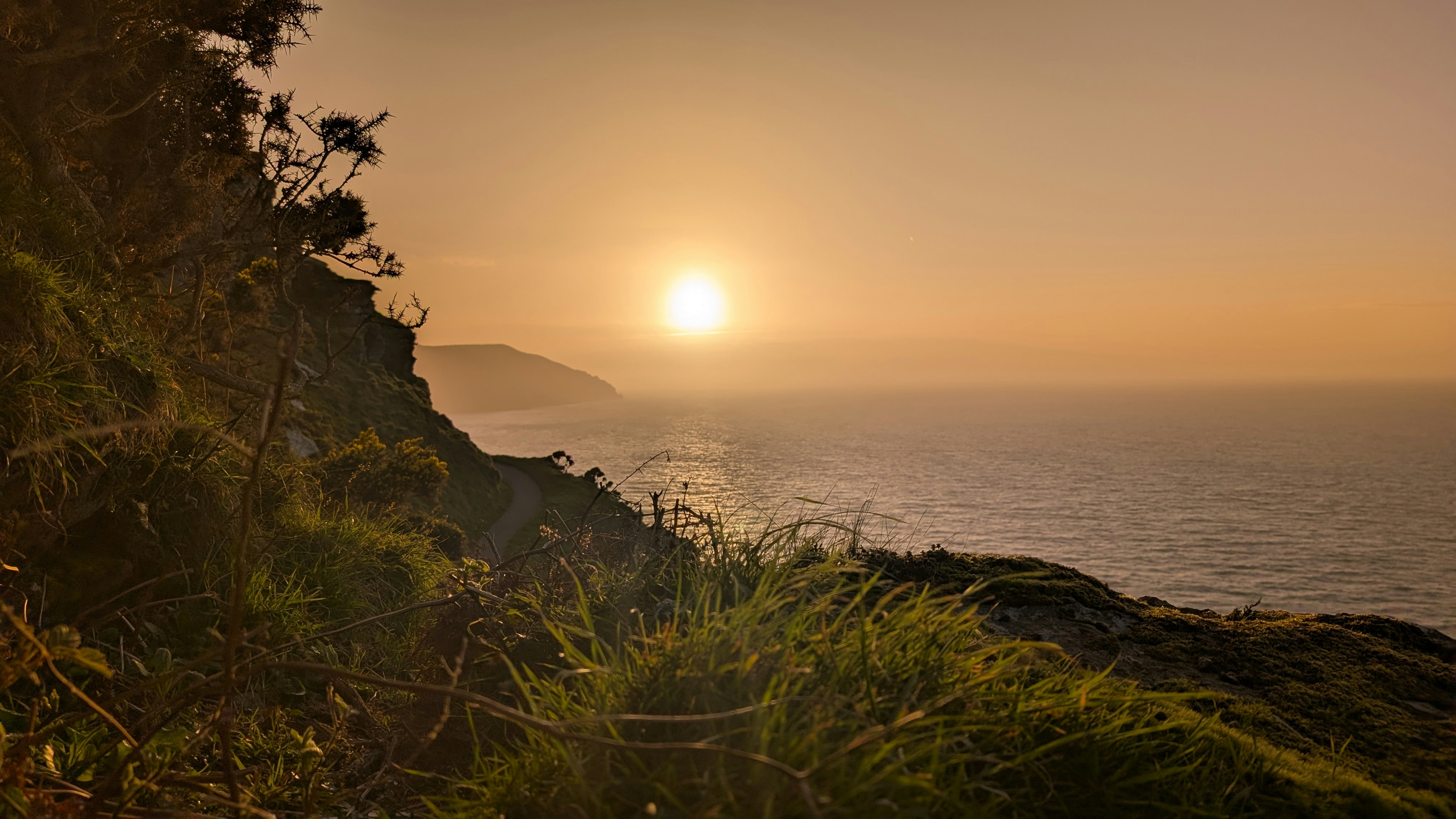 Sunset Over Coastal Cliffs: Quiet Light on the Edge