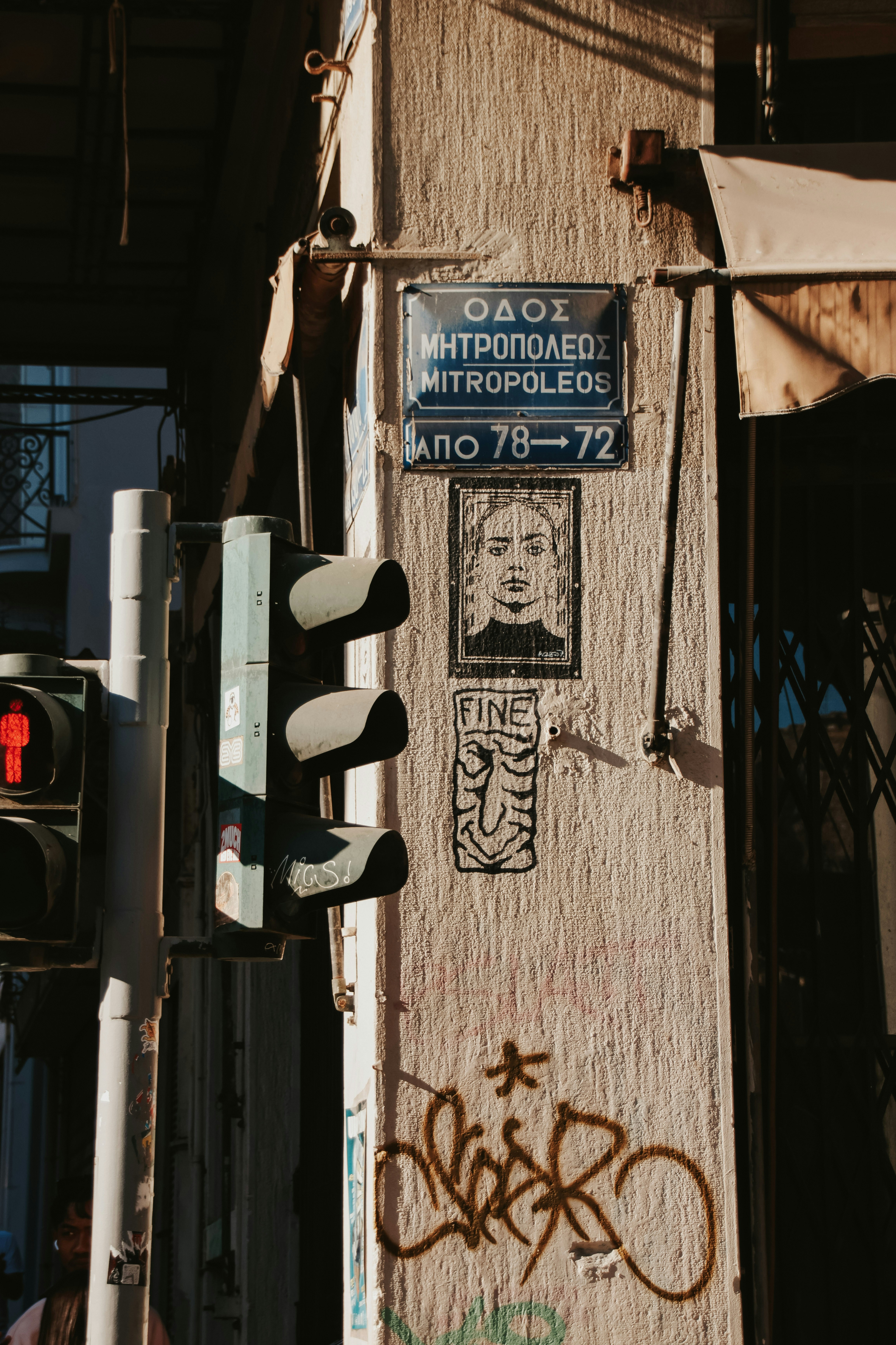 Urban Facade: Graffiti, Signage and a Quiet Portrait on a Corner Wall
