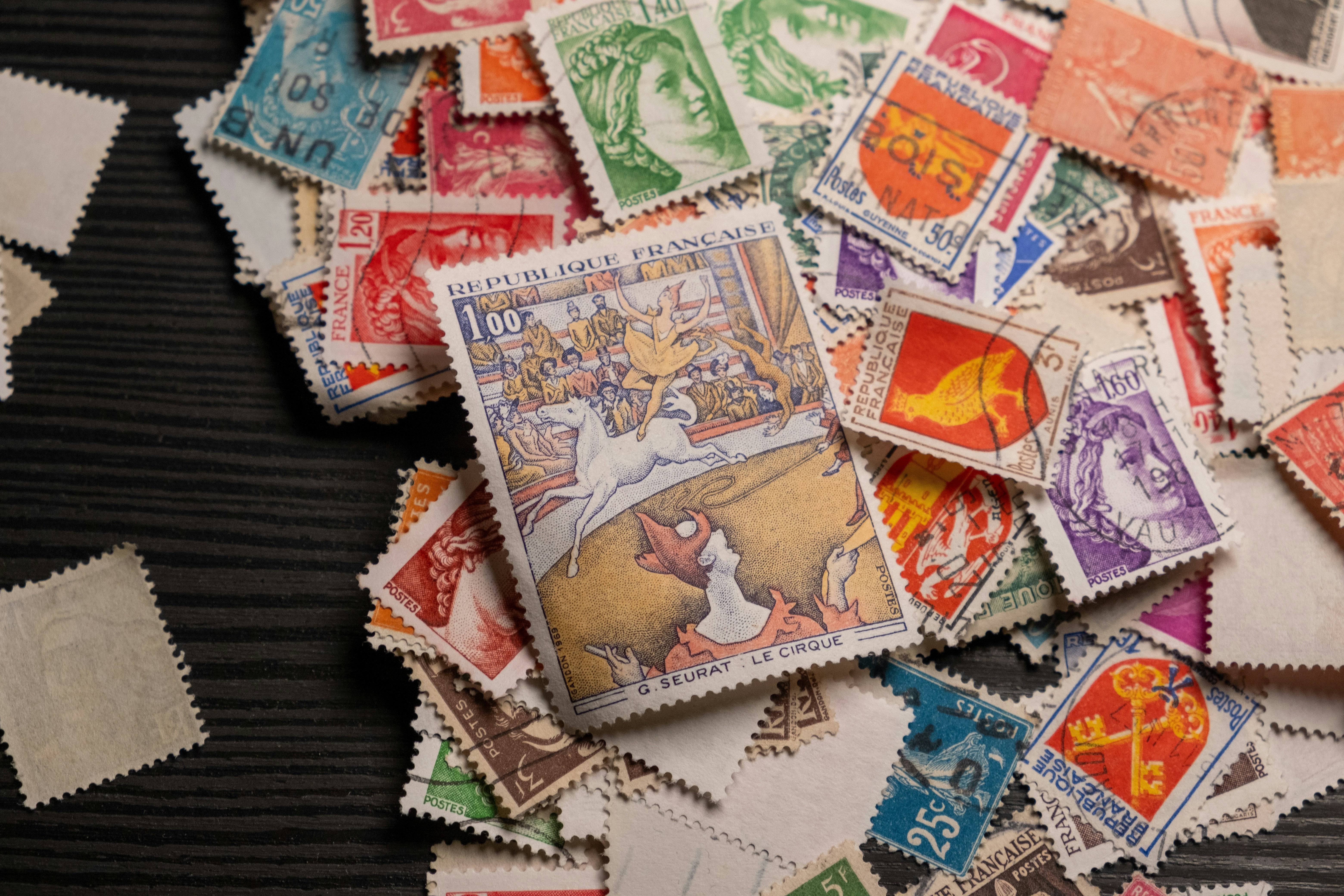 A Mosaic of Stamps: Colorful Memories scattered on a Dark Surface