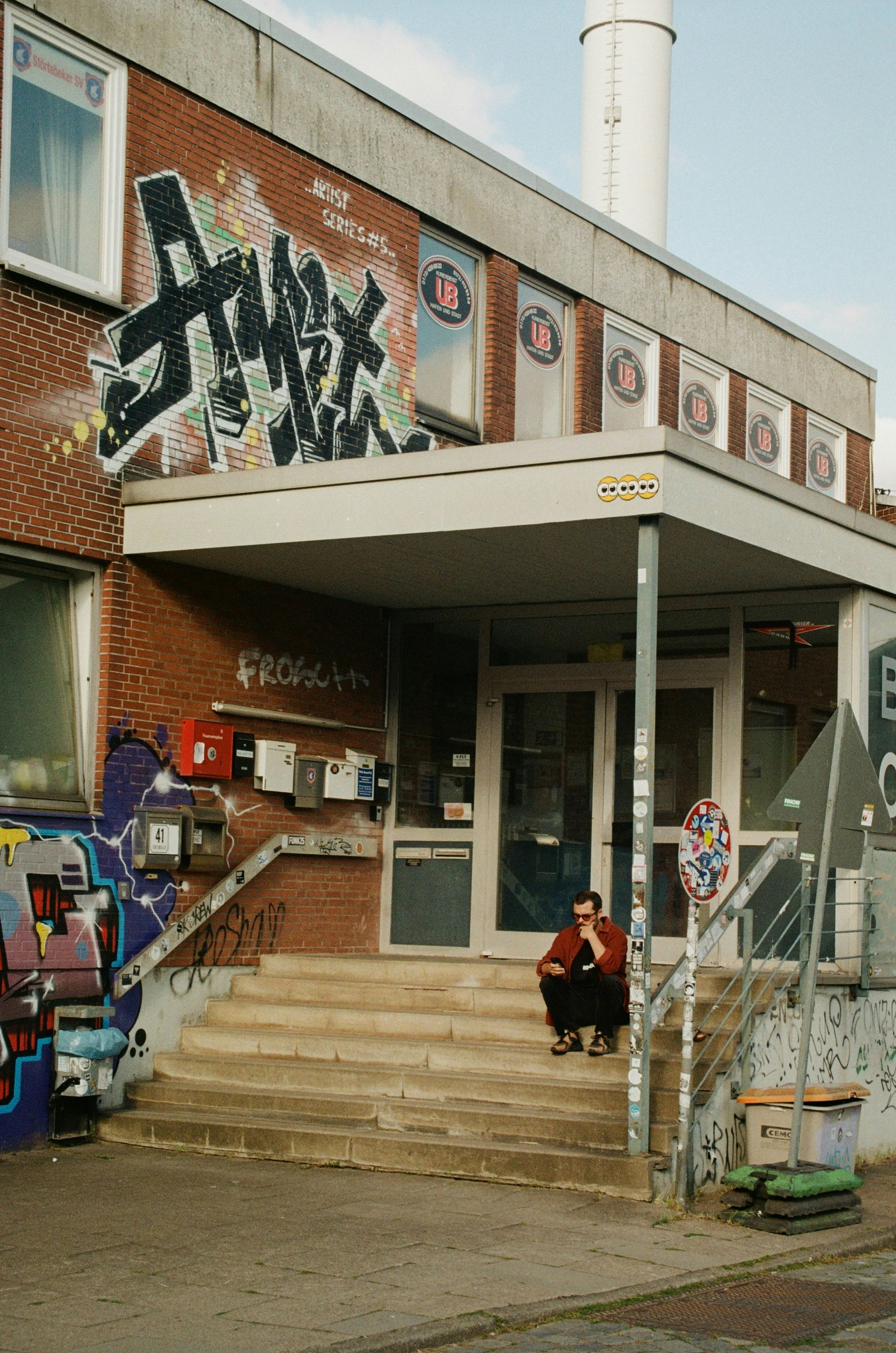 Graffiti-Strewn Admin Entrance: A Quiet Moment on the Steps