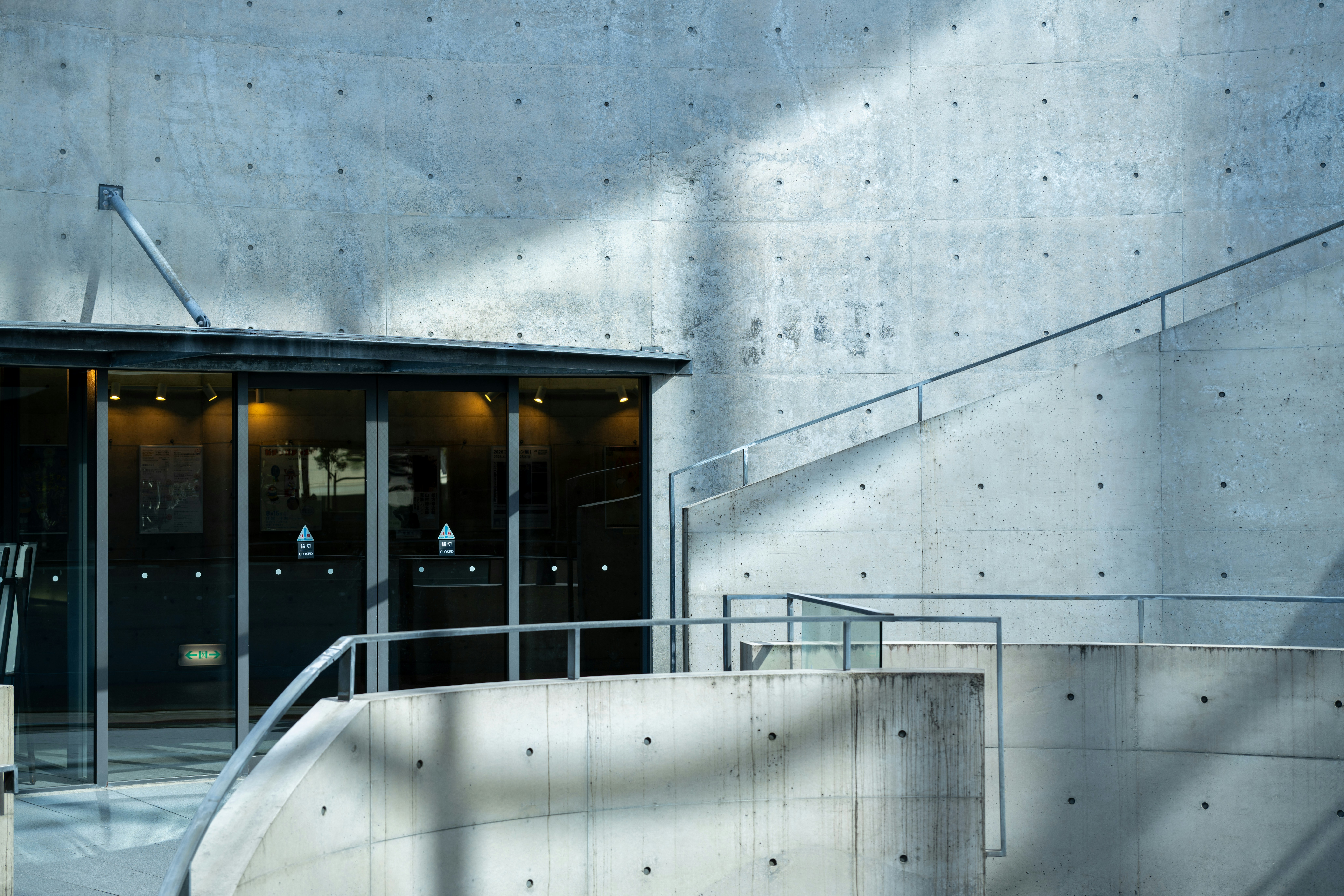 Concrete Geometry: Steps, Railings, and Glass Reflections