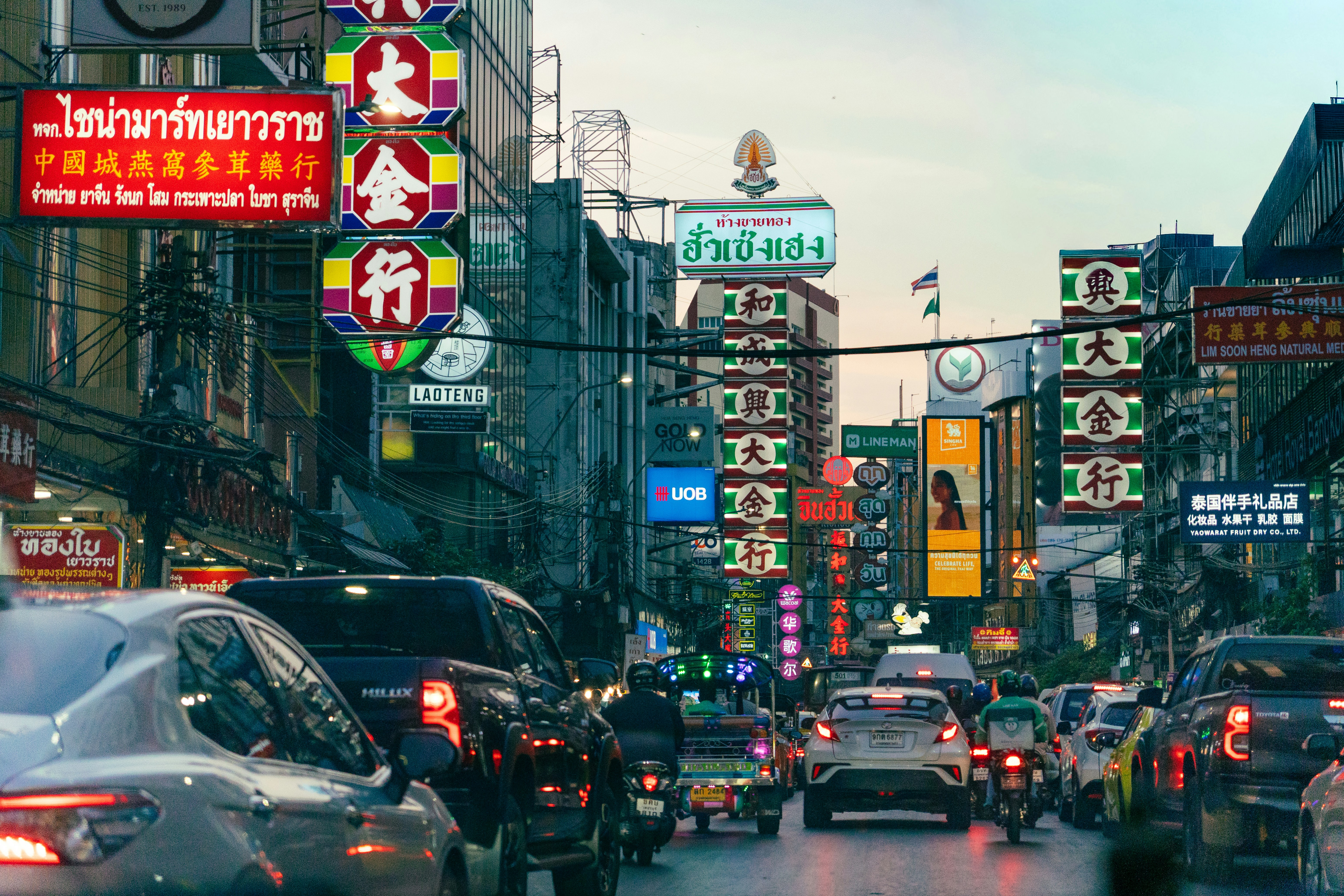 Neon Tangle: Bangkok’s Bustling Neon Corridor at Dusk