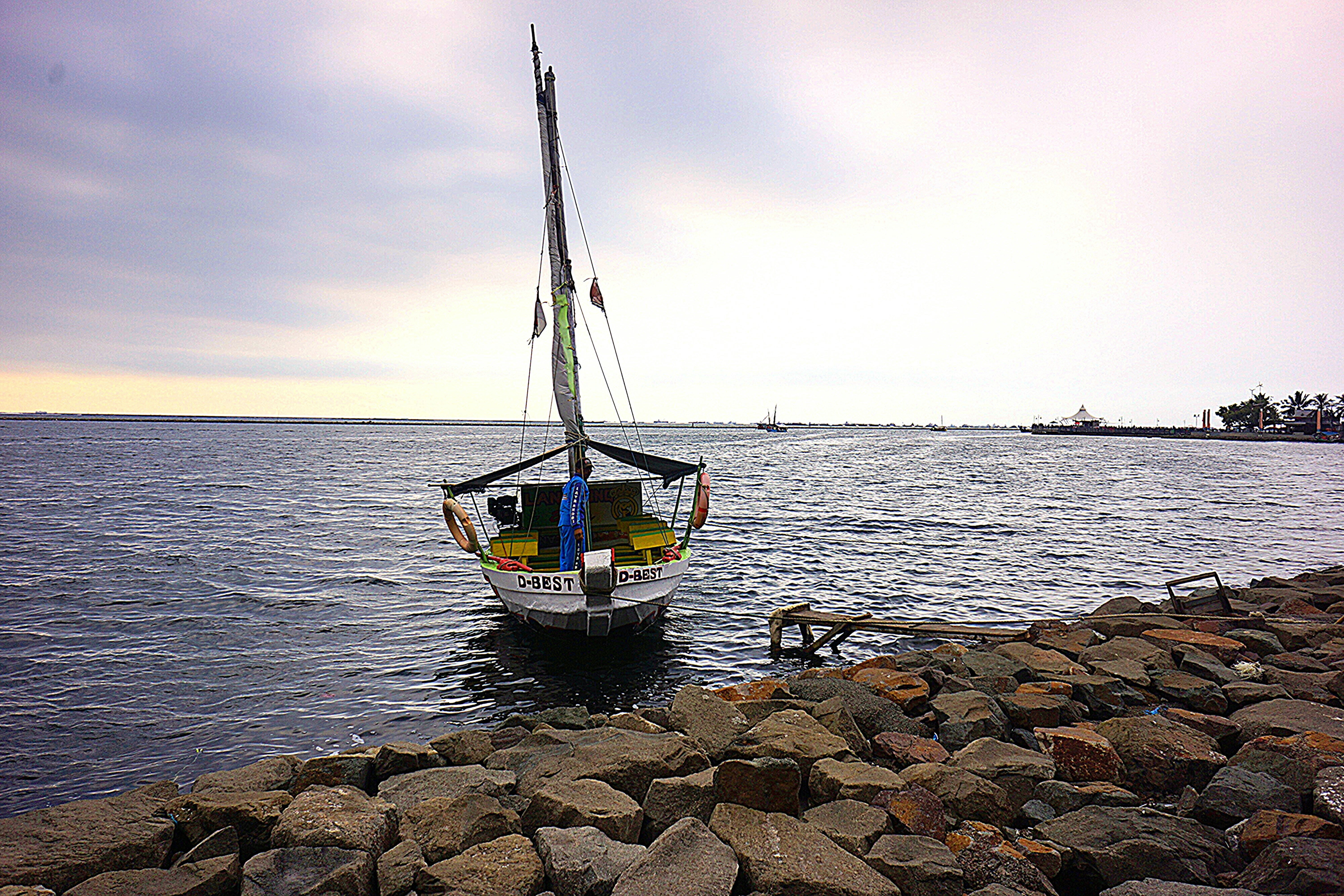 Boat at the Breakwater: Quiet Harbor at Dusk