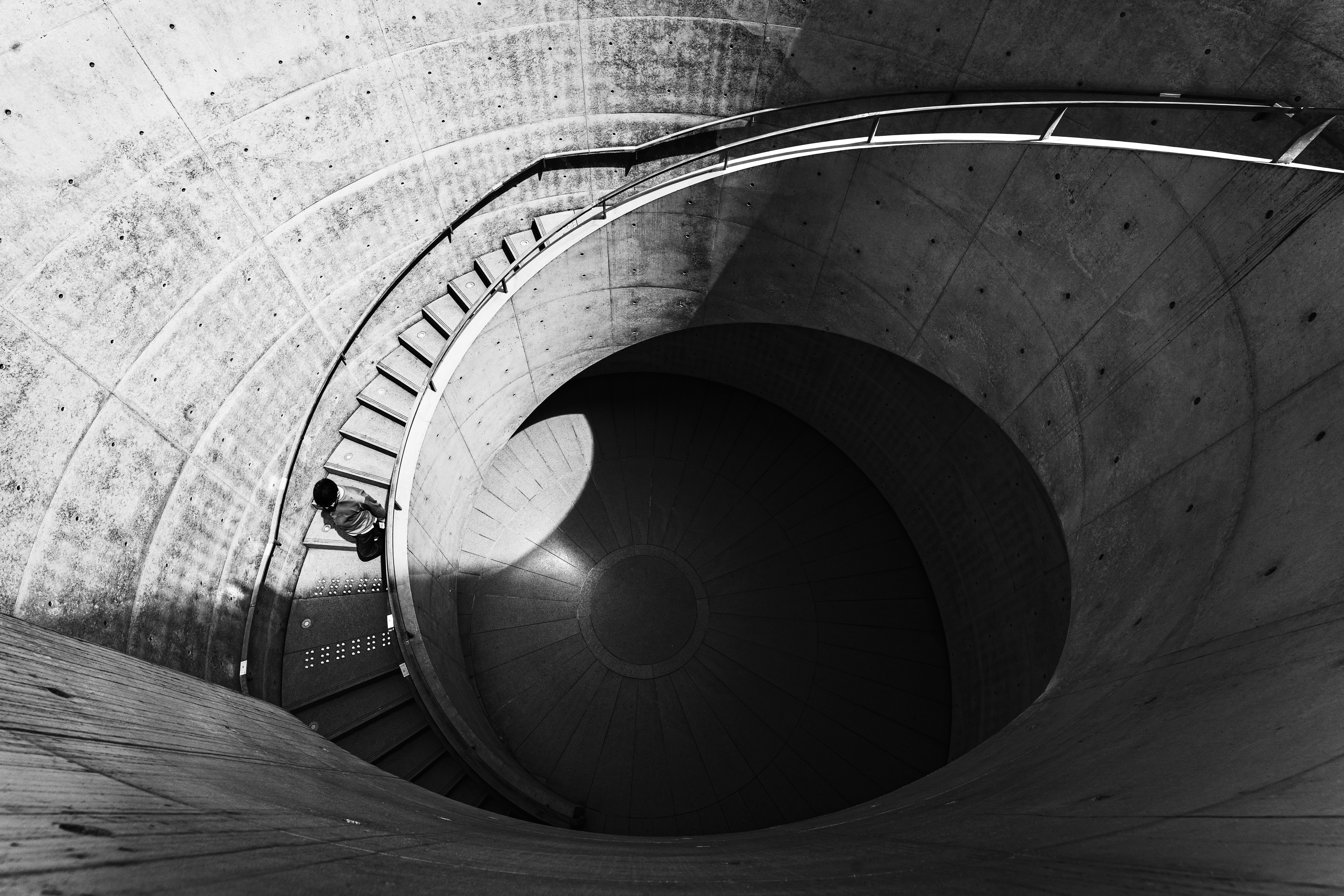 Spiral Descent: A Concrete Atrium's Silent Coil