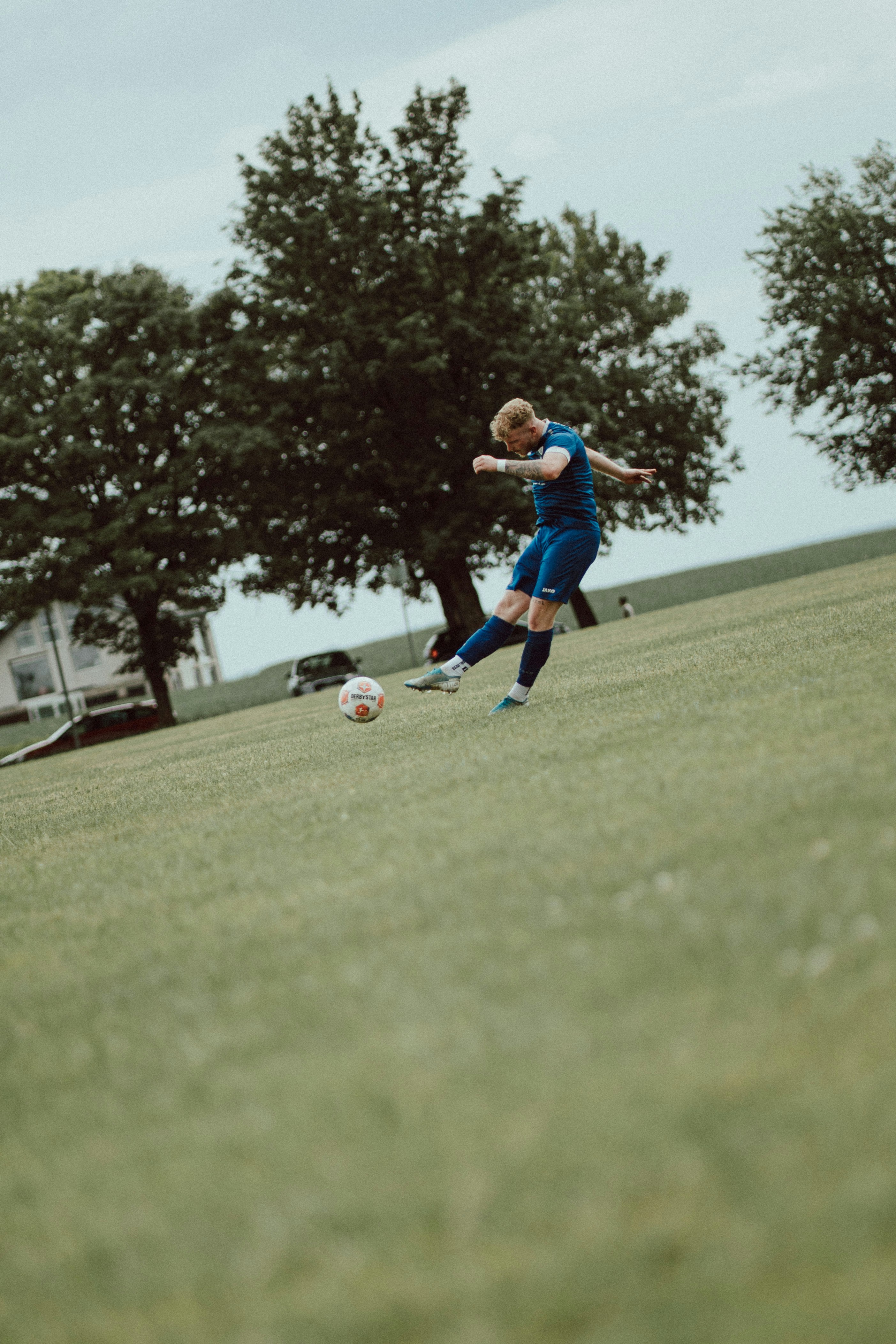 Blue Kit, Silver Ball: A Moment of Fieldplay on a Quiet Hill