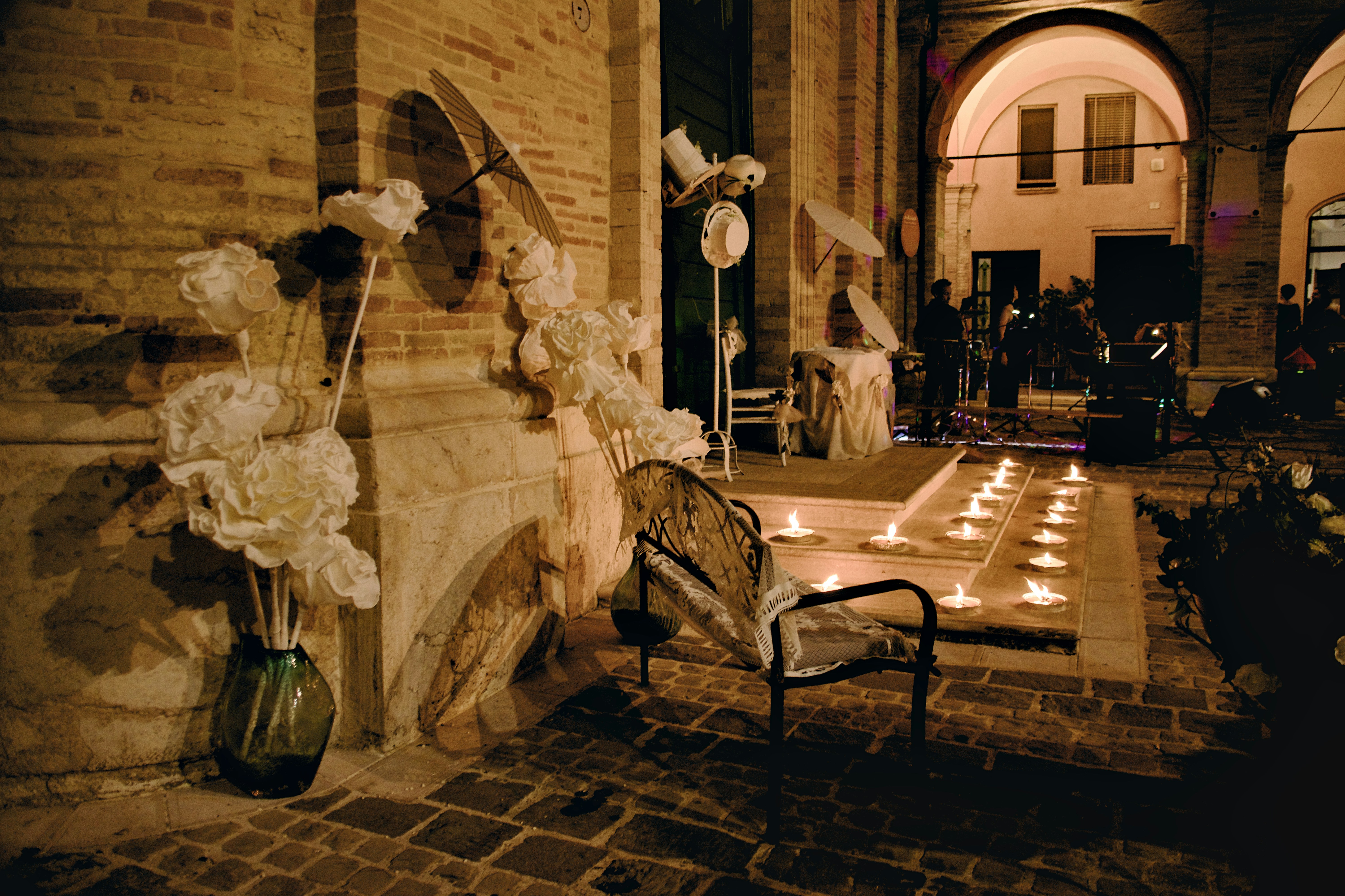 Candlelit Courtyard Reverie: Quiet Seating Beneath Arched Windows