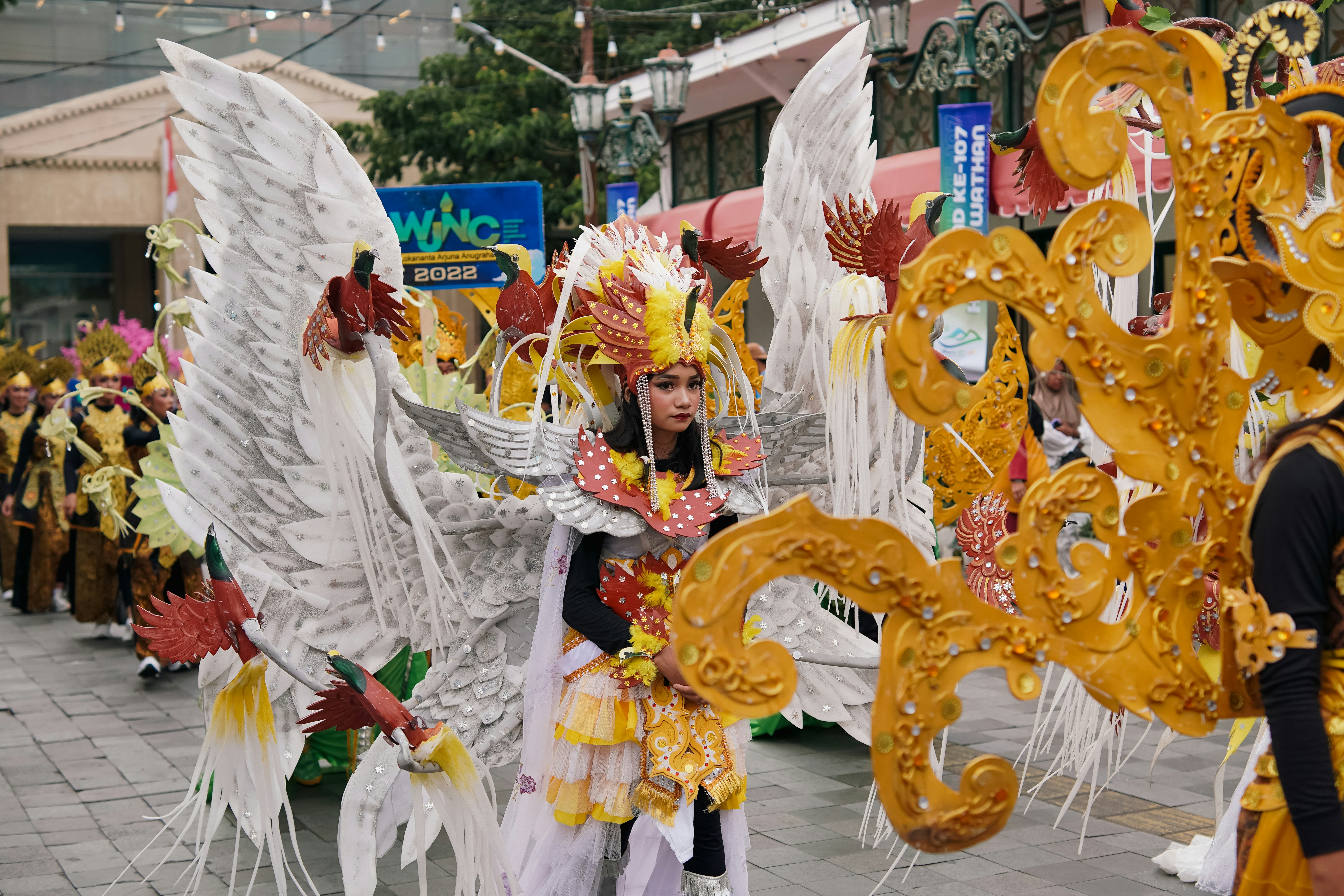 Winged Dancers in a Golden Parade