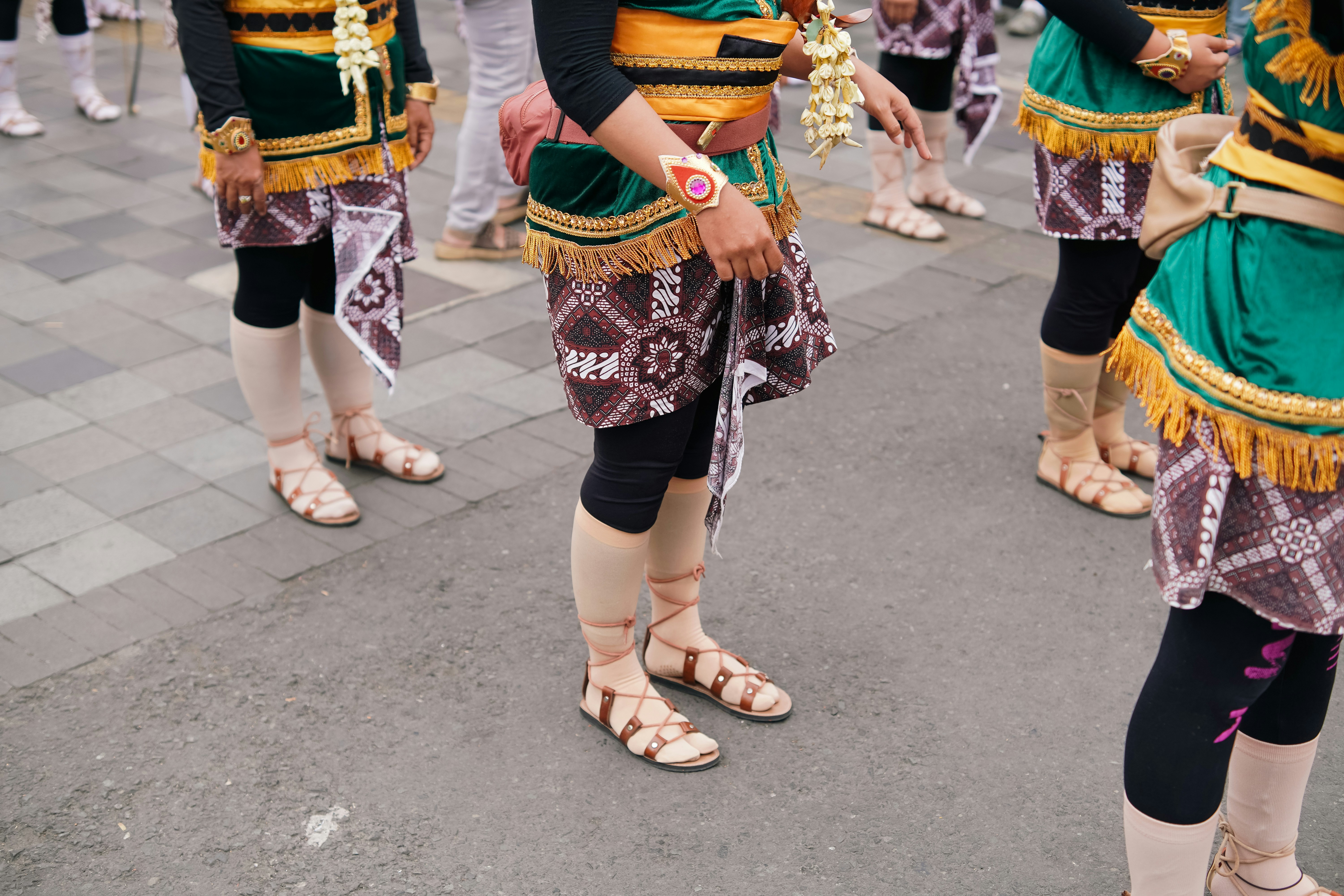 Steps in Rhythm: Clad in Traditional Garb on a City Street
