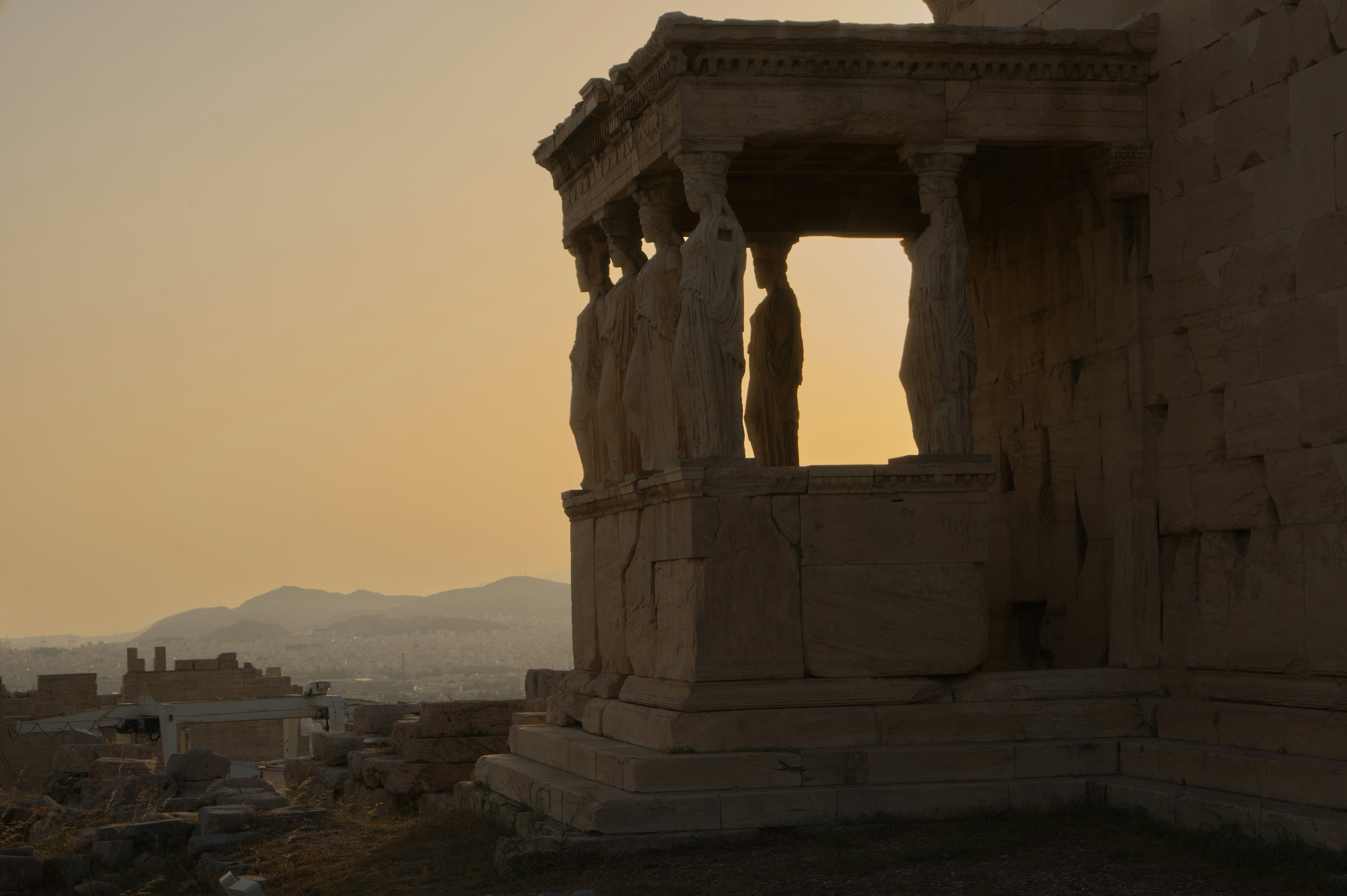 Sunset silhouette within the Parthenon-like ruin