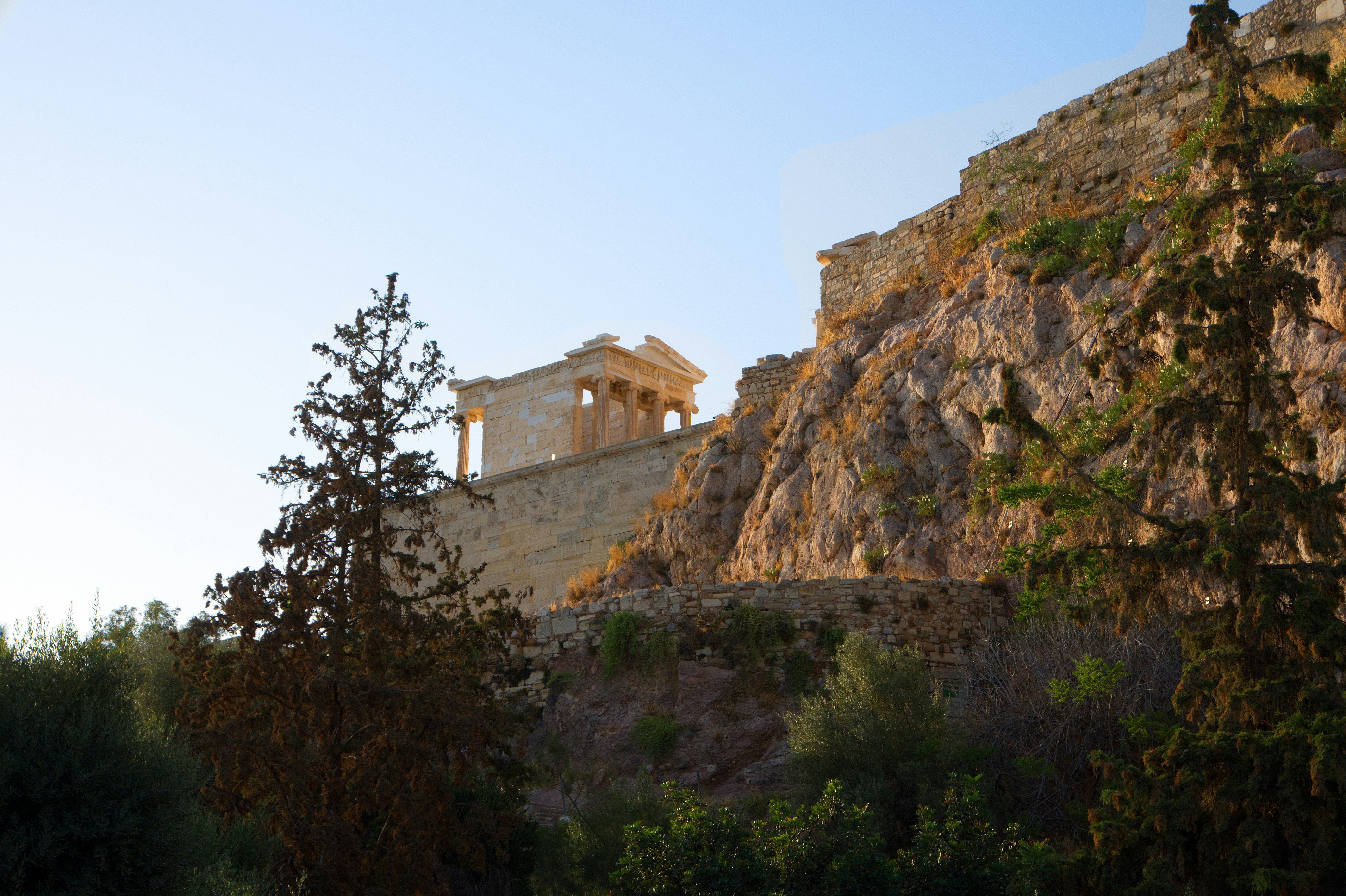 Ancient Temple Framed by Cliff and Pines