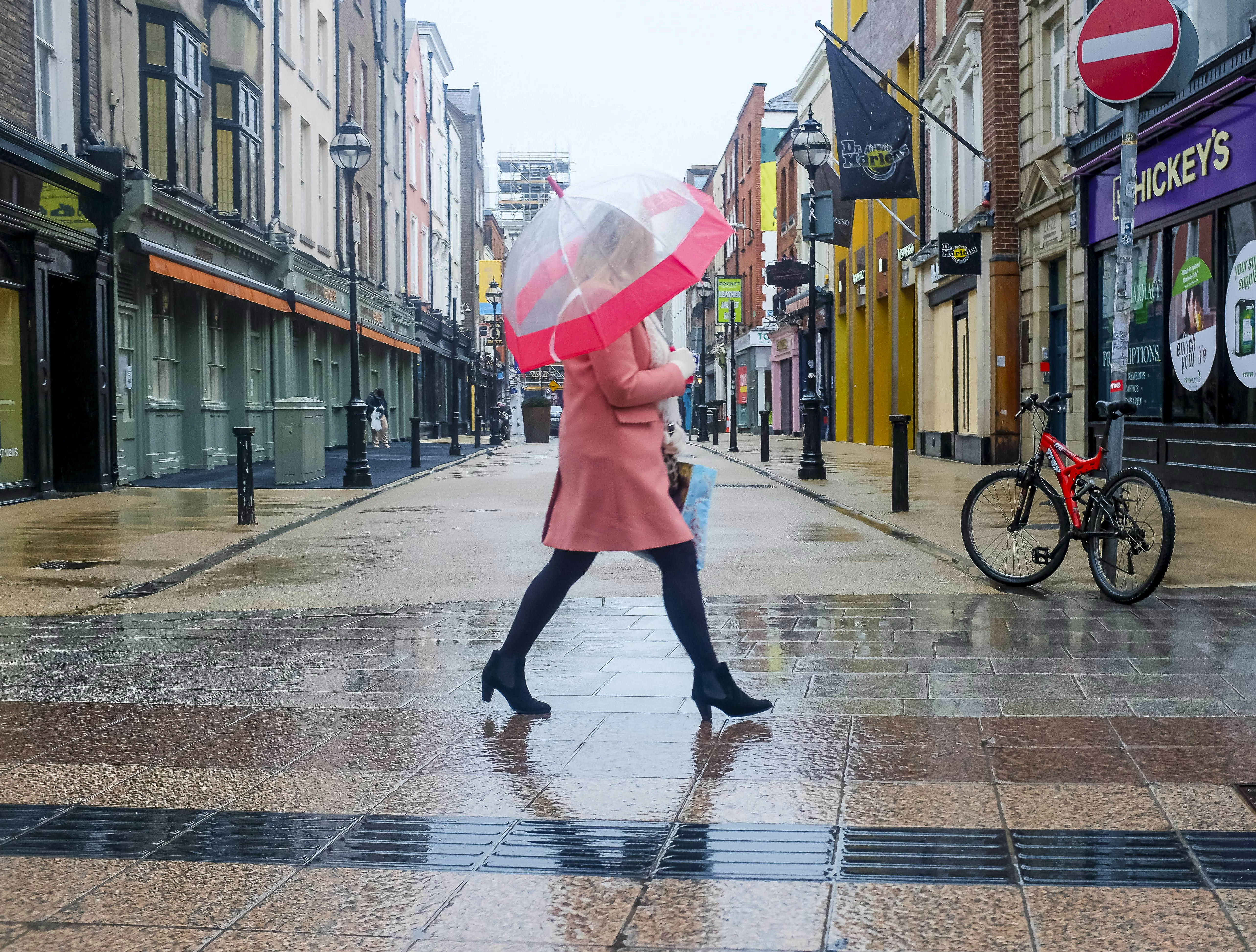 Red Umbrella Walk: A Pink-Coat Moment on a Rain-Slick Street