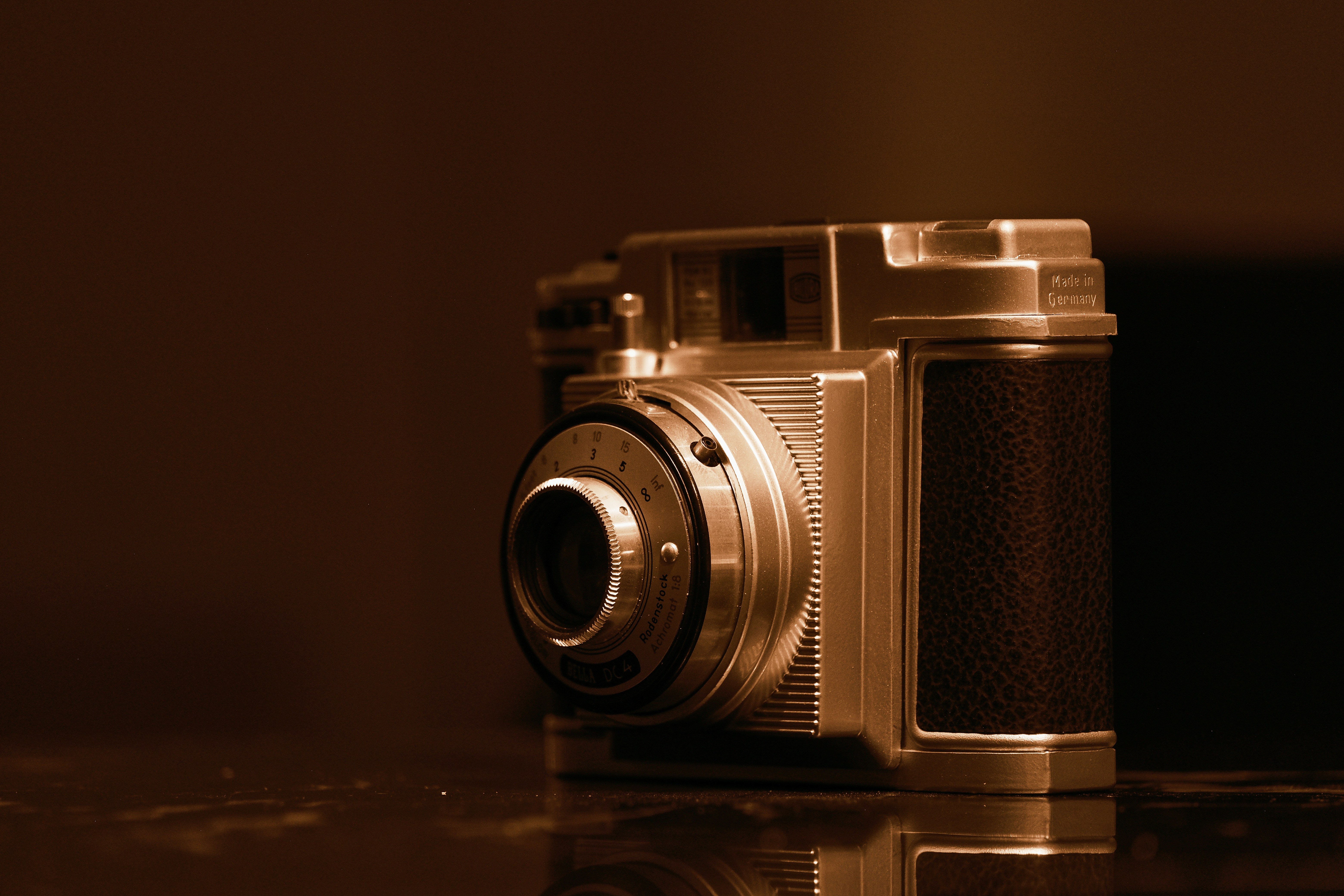 Vintage Seeker: A Classic Rangefinder Resting on Its Shadowy Stage