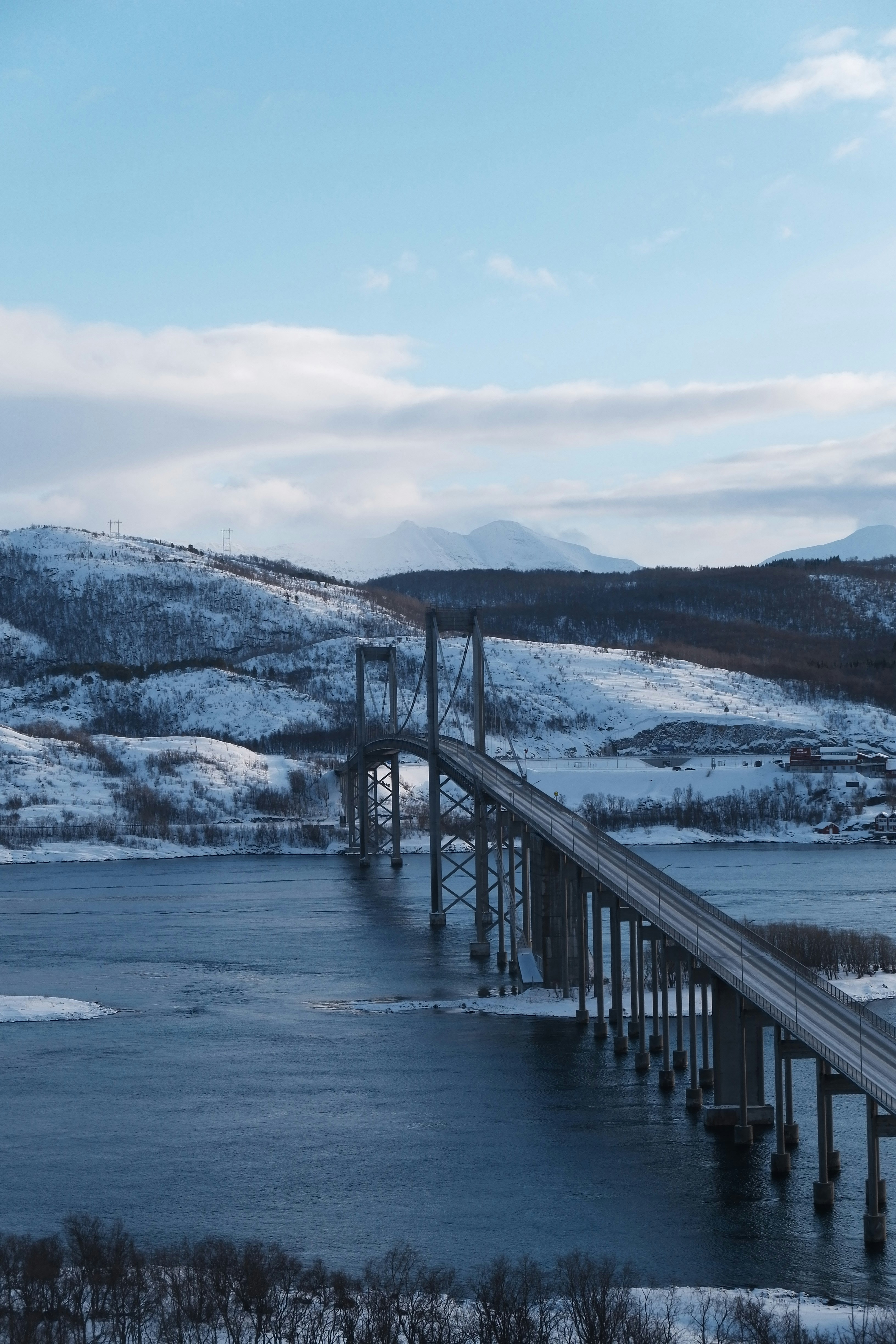 Snowbound Span: A Long Bridge Reaching Across Quiet Waters