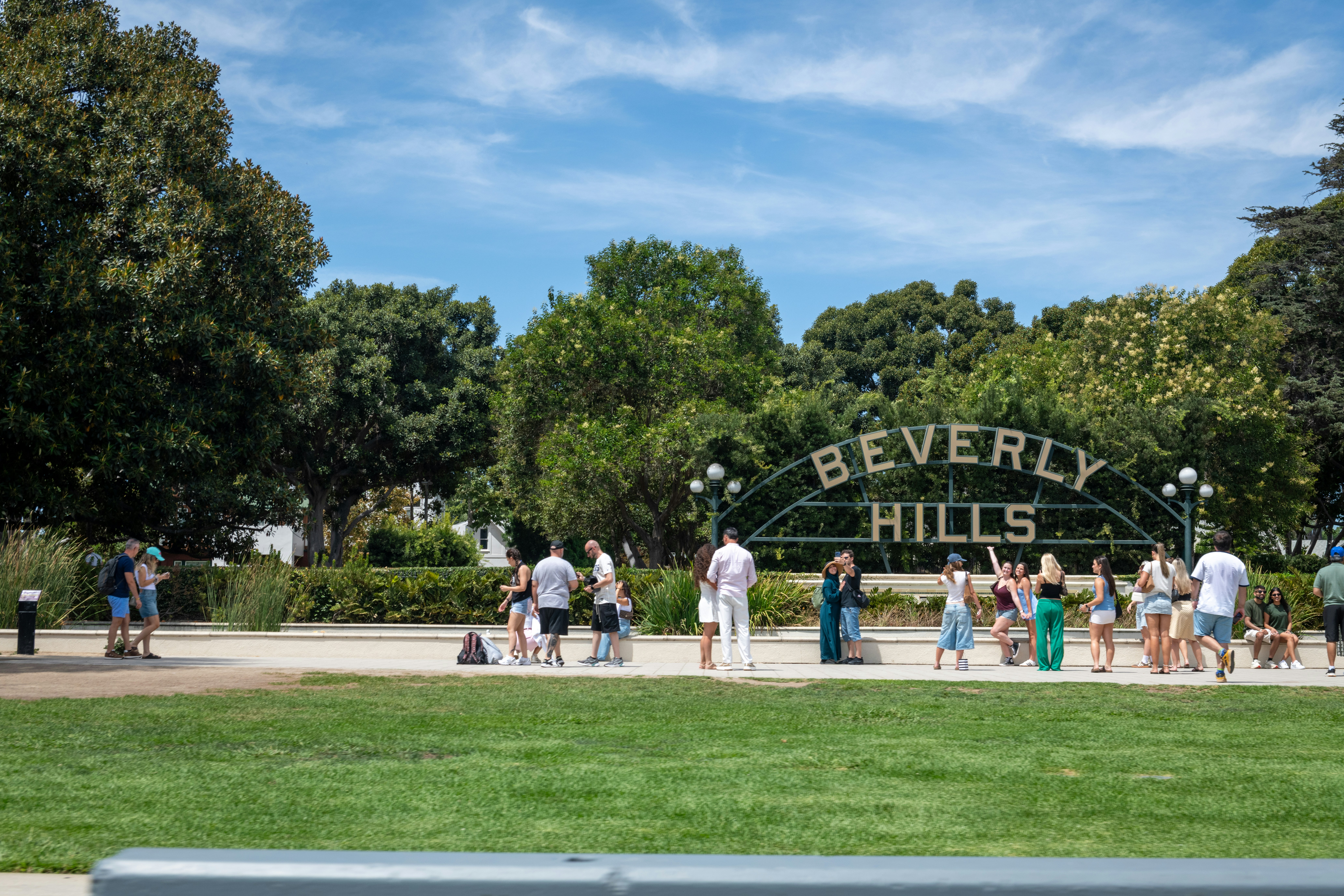 Entryway to Beverly Hills: People Gather Under the Arch