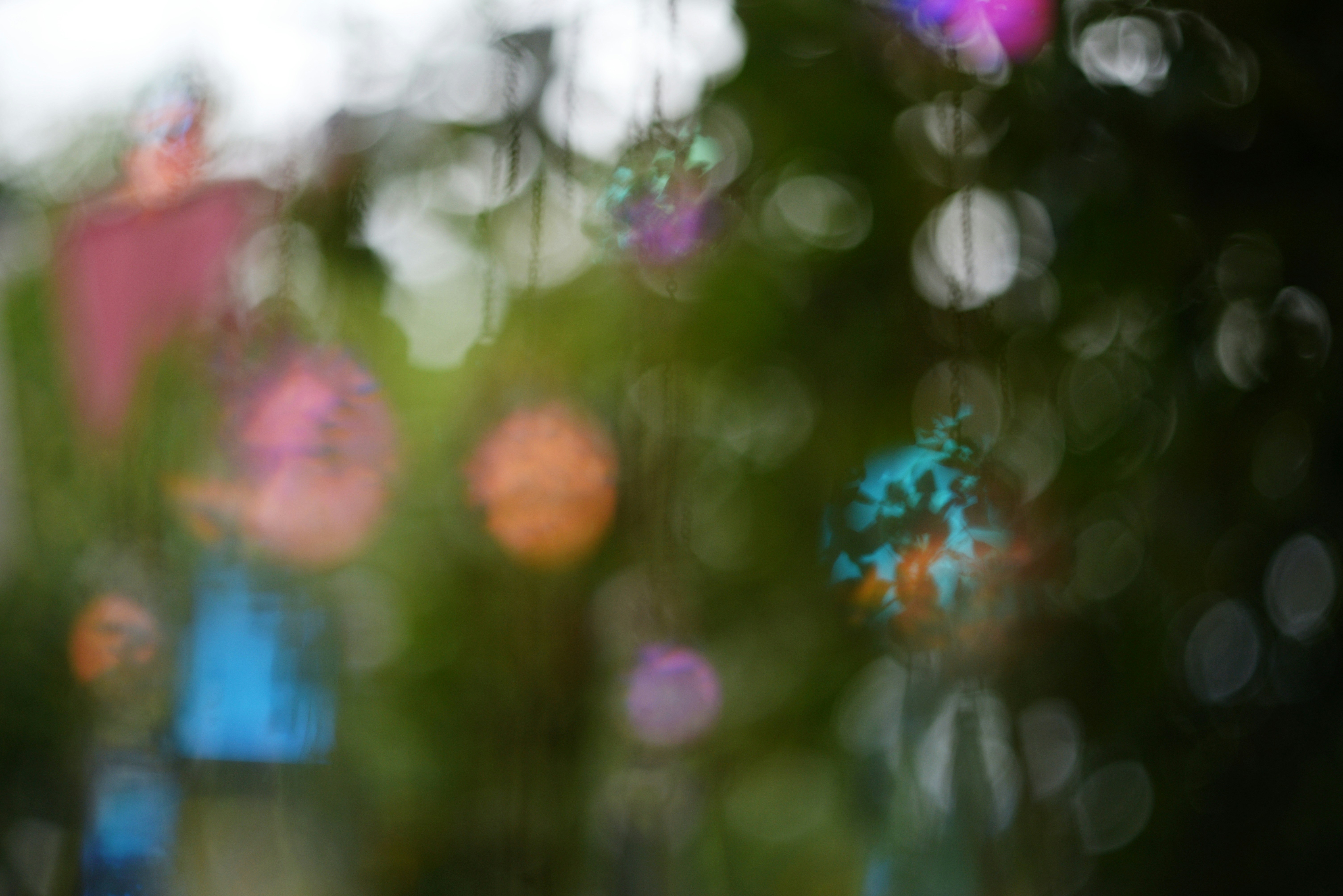 Glass Orbs in Bloom: Quiet Bokeh of Colorful Dangles