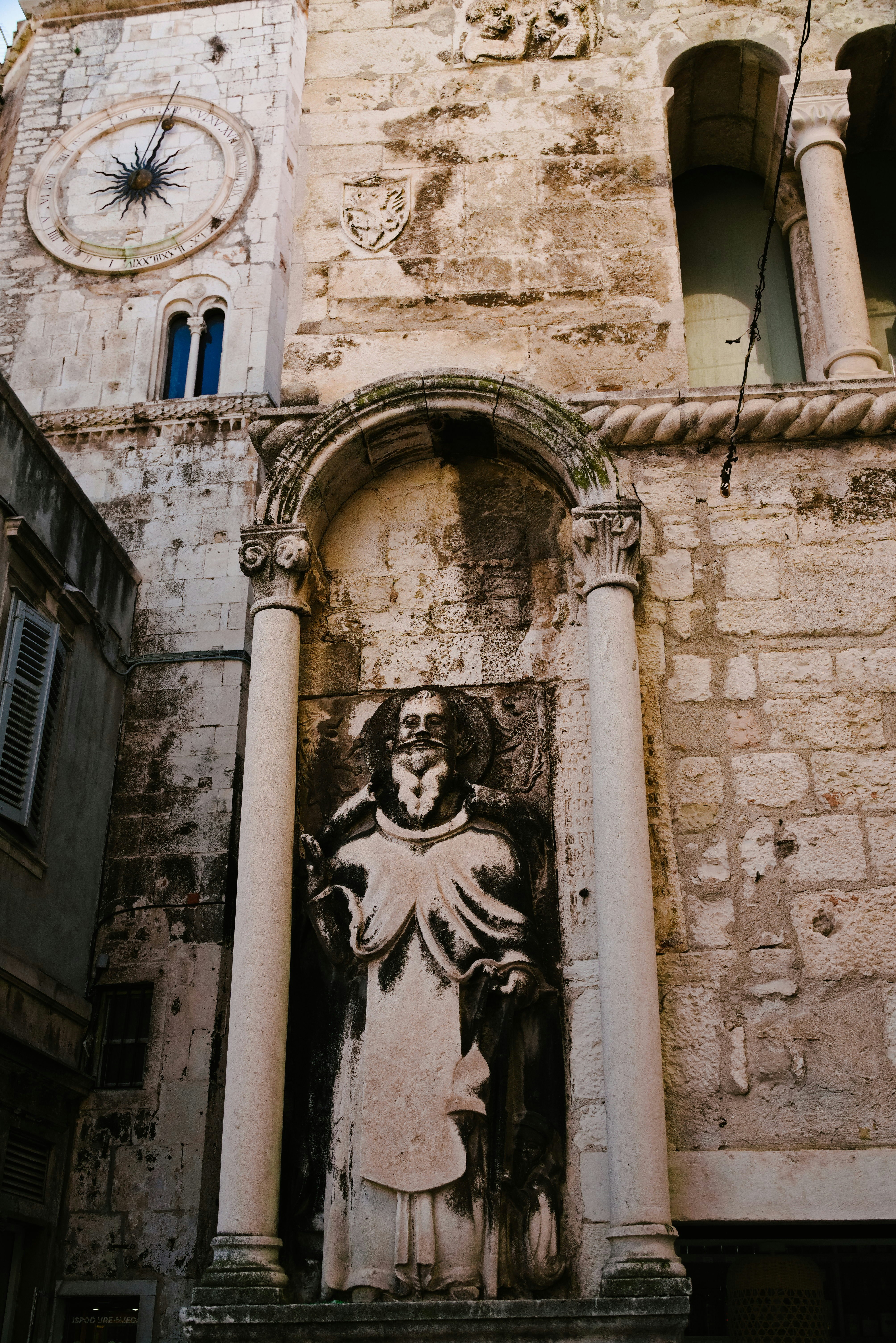 Stone Figureguard: A Silhouette of Time Amid Archways