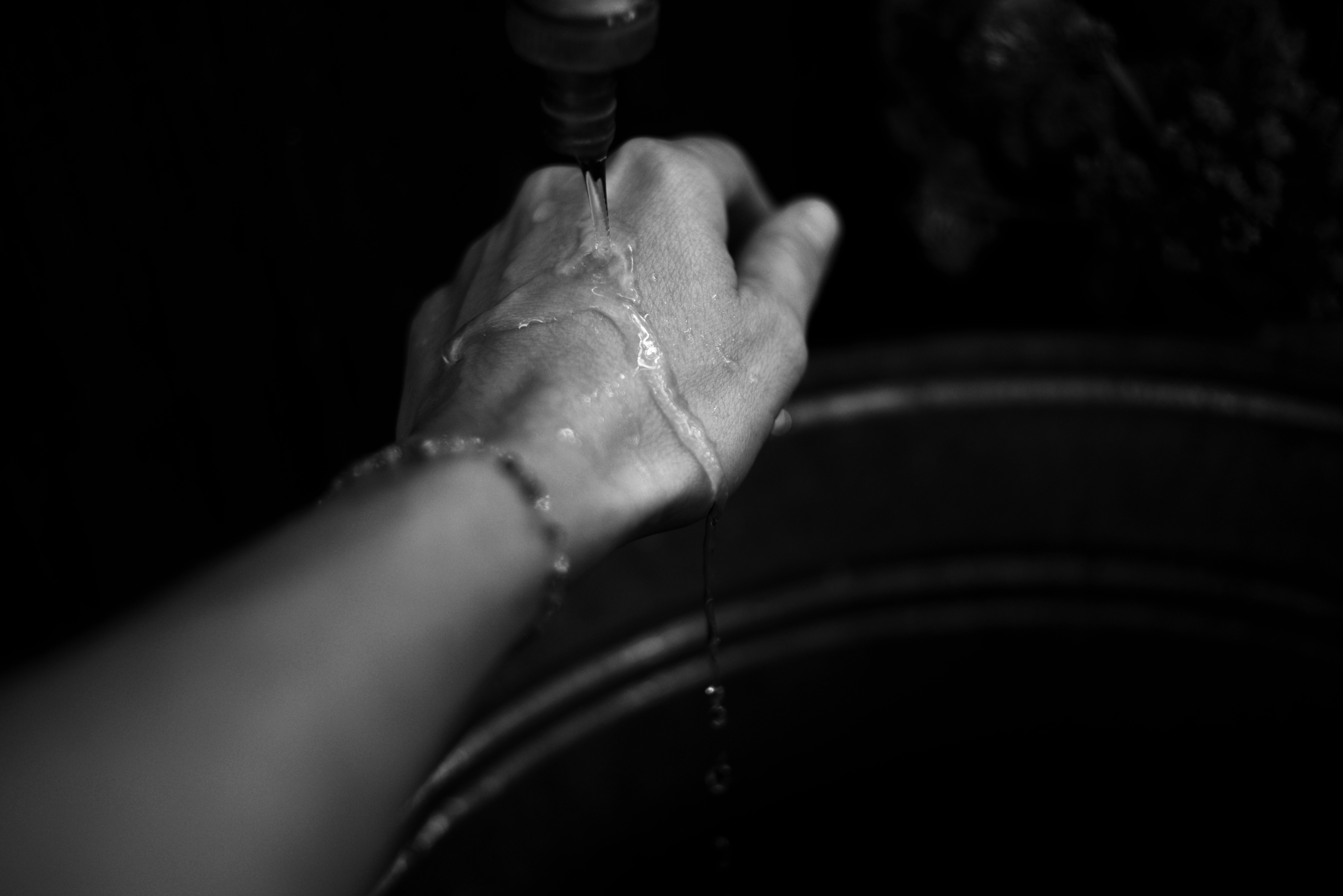Drip of Light: A Hand Under a Draining Tap