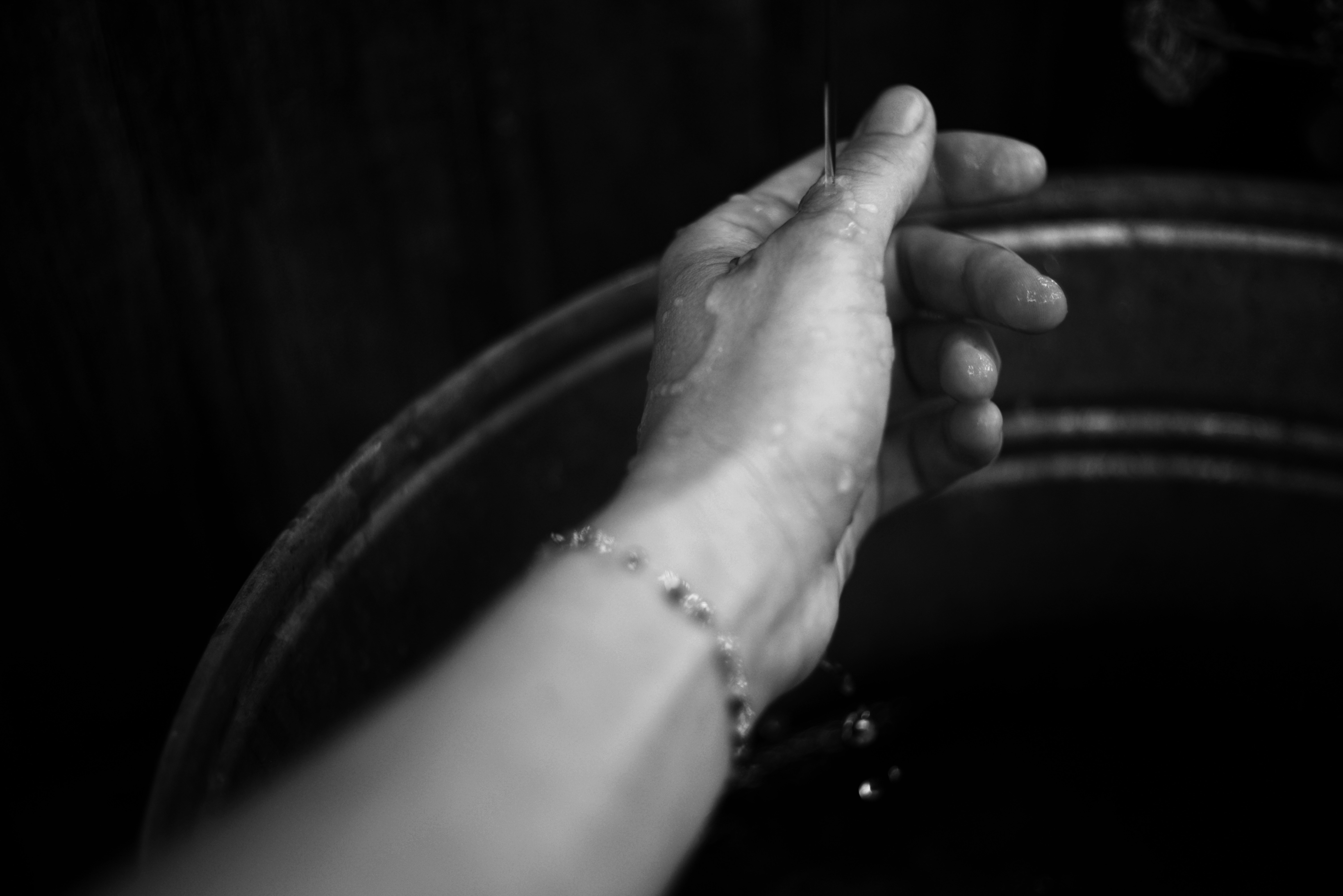 Silken Thread: A Delicate Gesture Over Dark Water