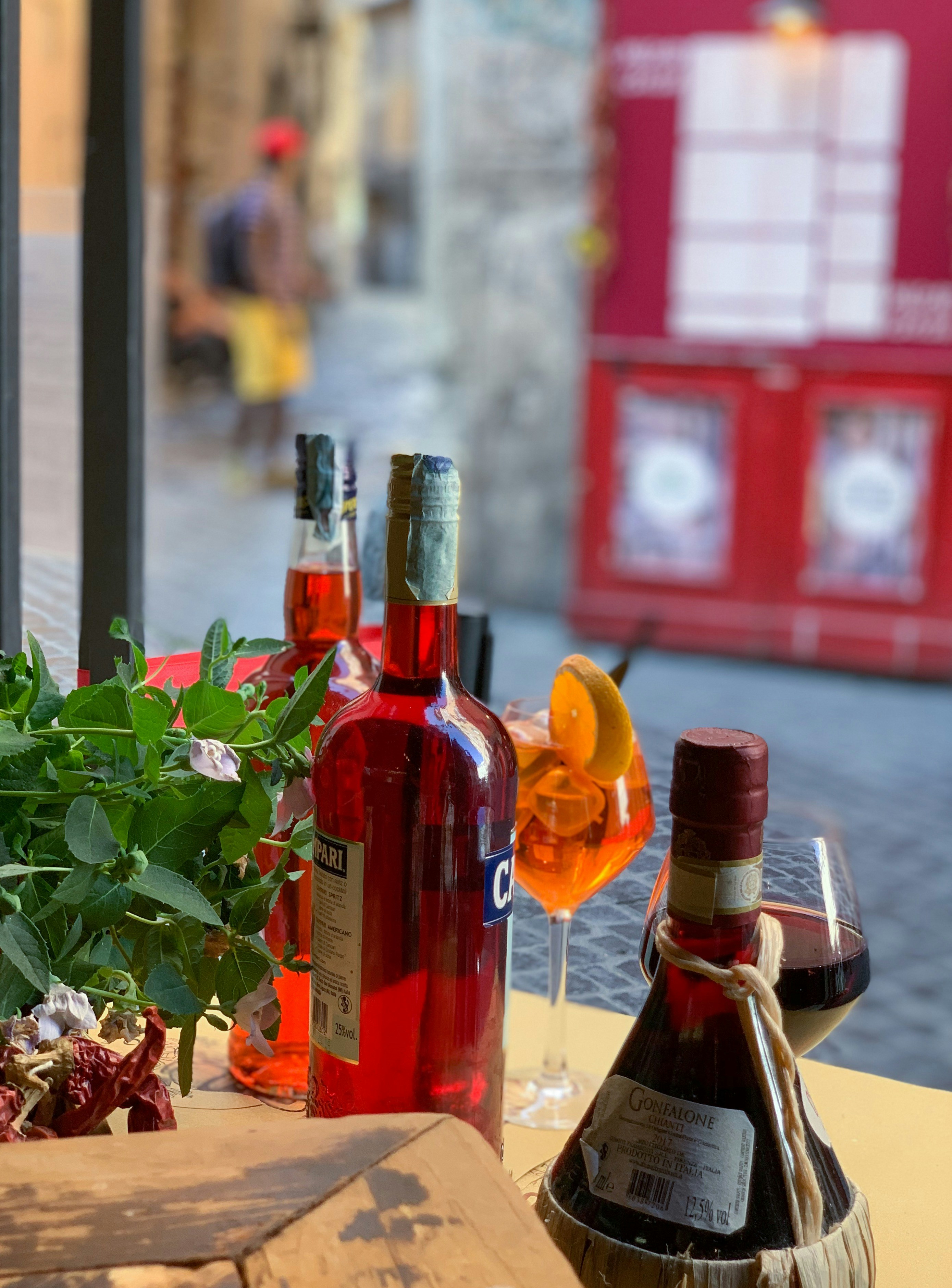 Sunset in a Lucrative Table: Bottles and Glasses on a City Corner