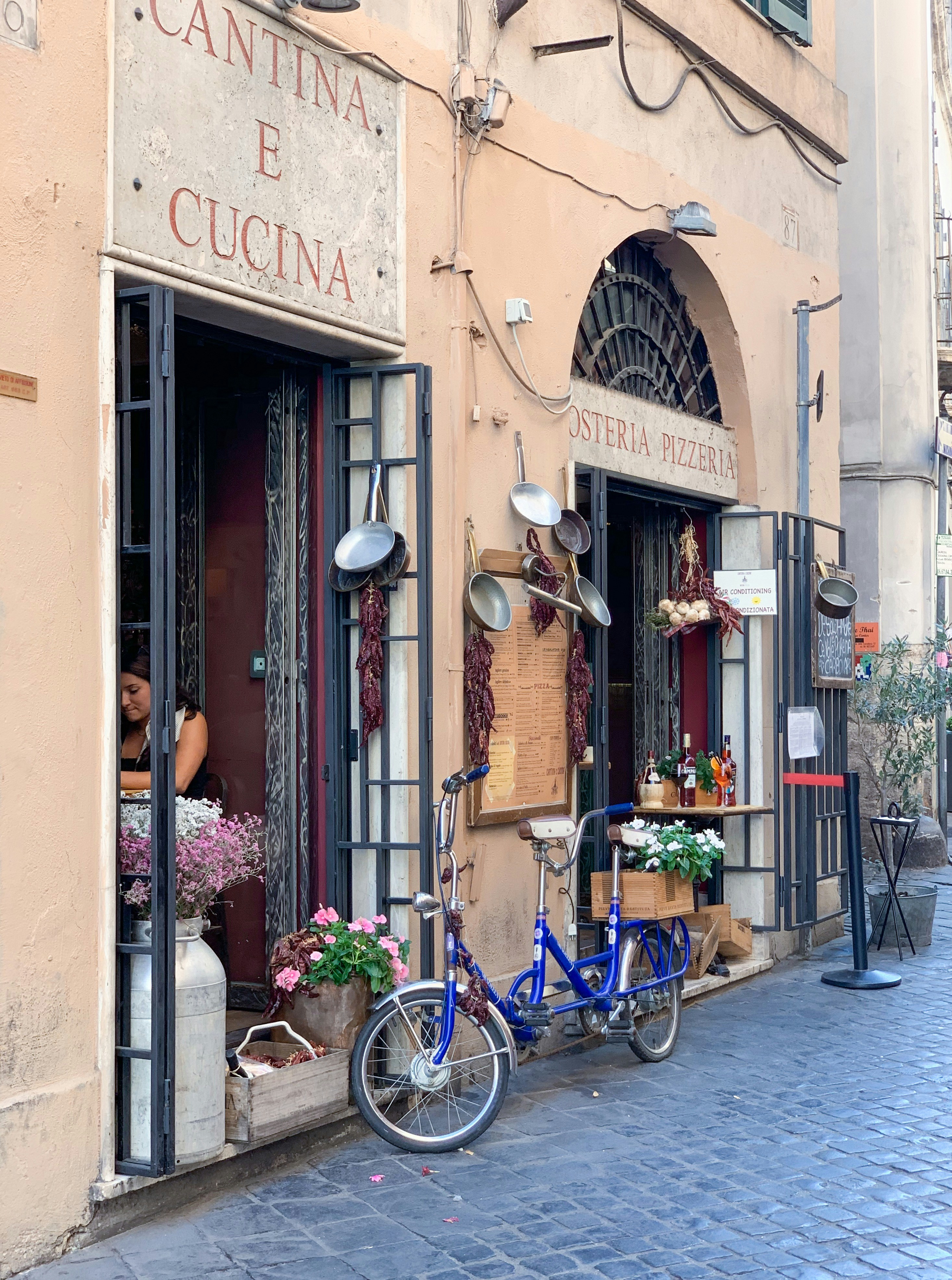 Cobbled Calleway Bistro: A Bicycle, Pots, and Pastry Signs