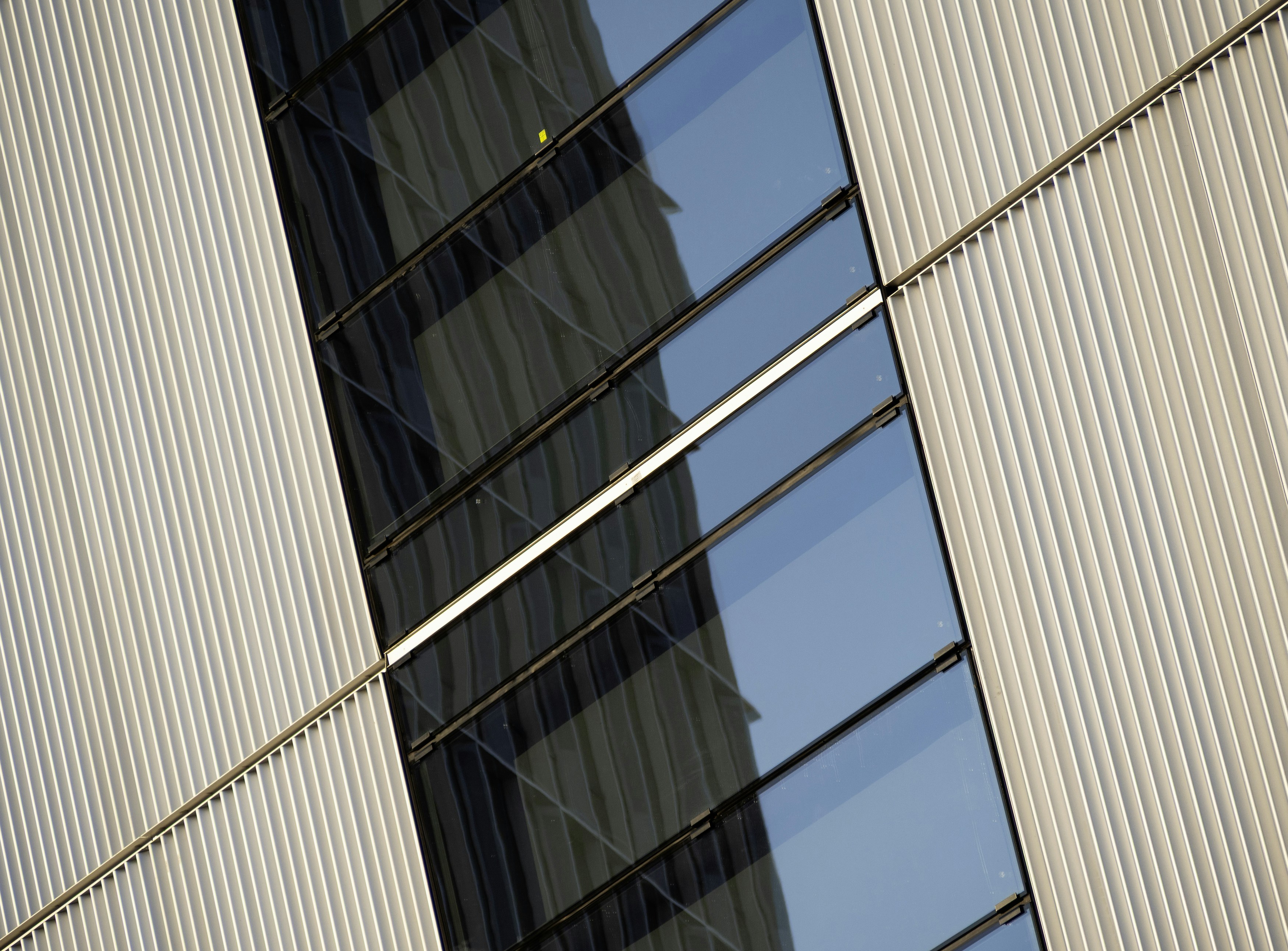 Angle of Glass and Steel: Vertical Stripes Meet a Slanted Glass Band