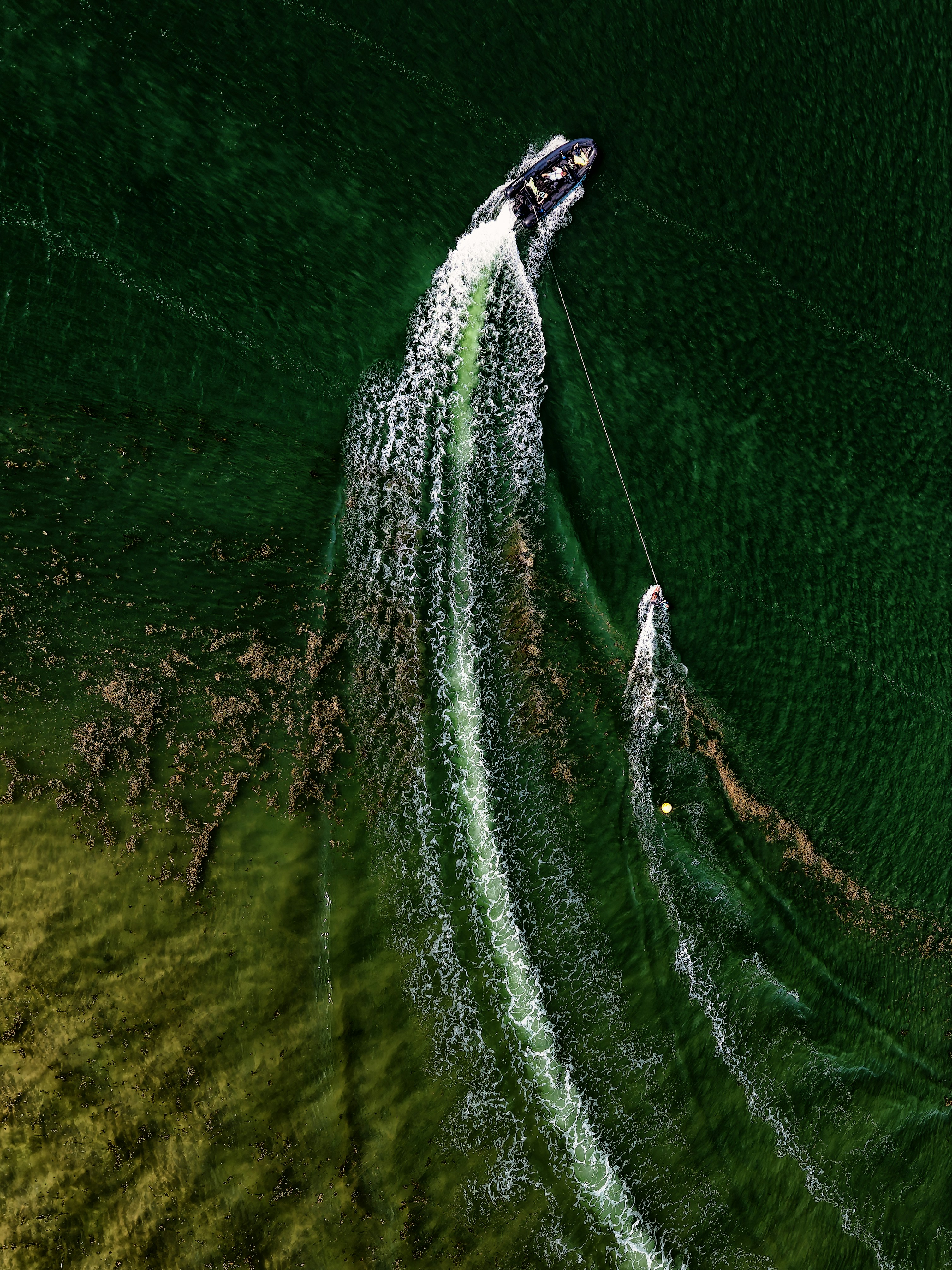 Wakeline: A Powerboat Drawn Ribbon through Emerald Stillness