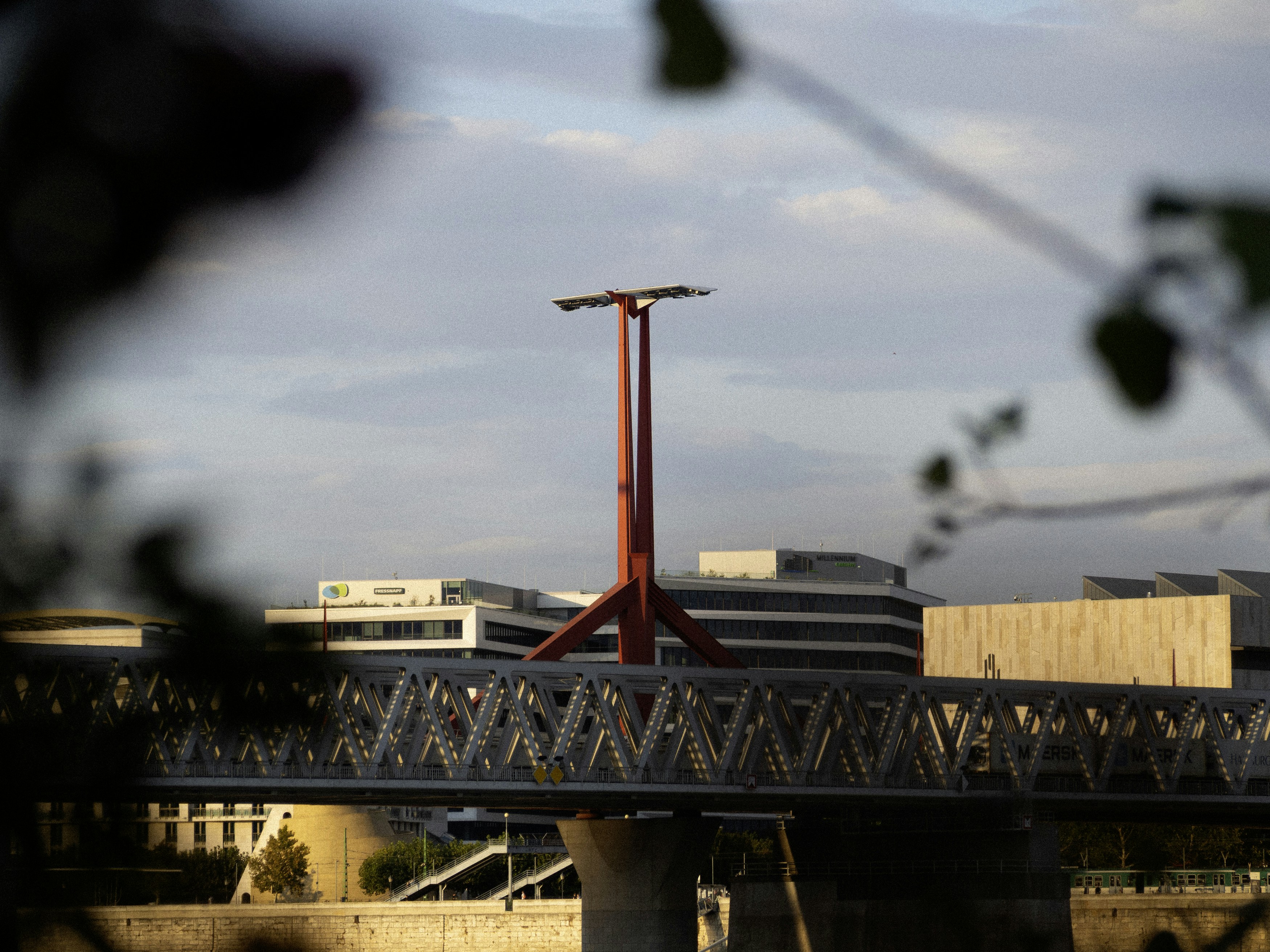 Red T-Frame Above the Urban Span