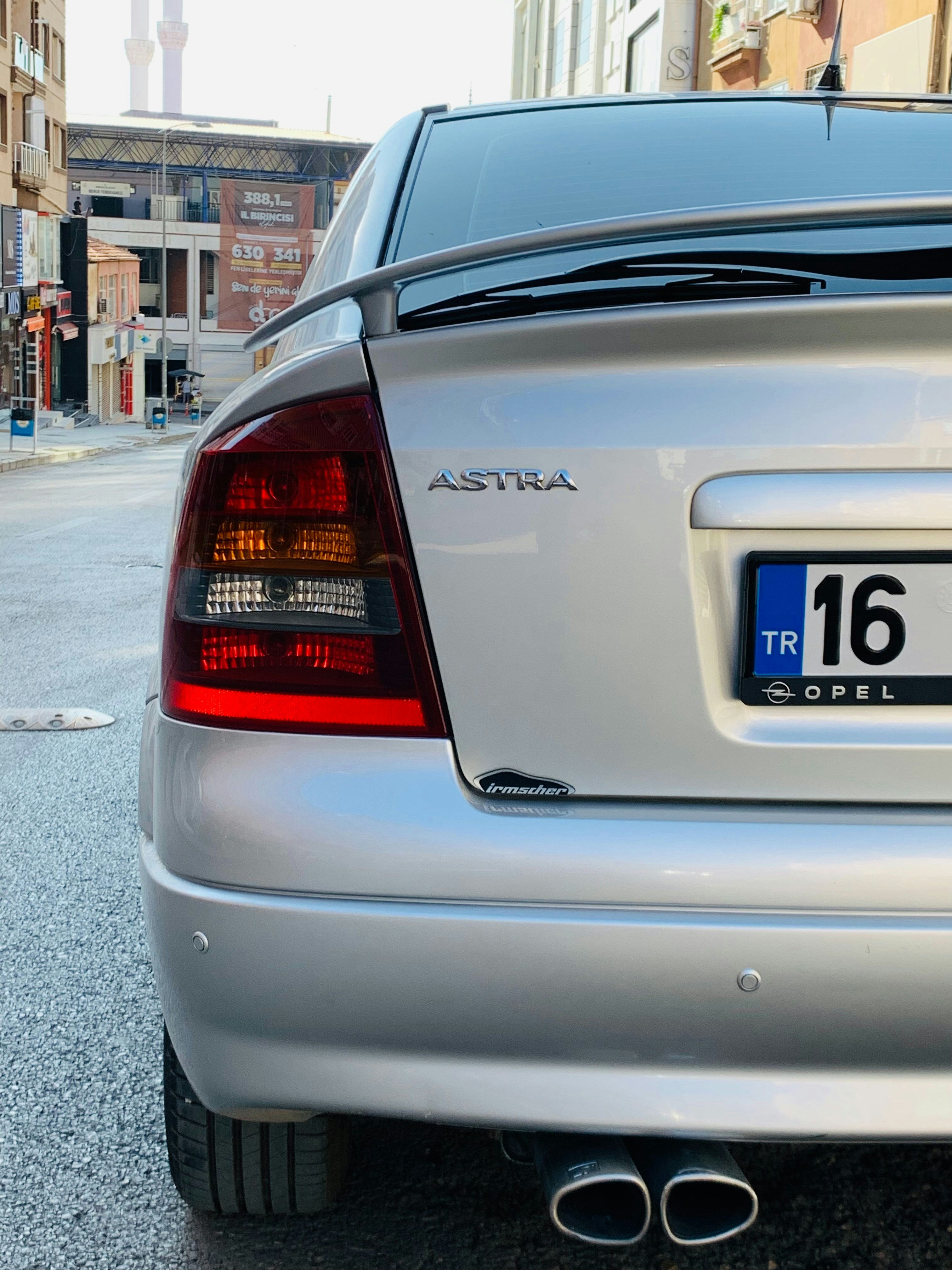 Rear View Resolve: The Astra Badge and Dual Exhaust in Urban Light