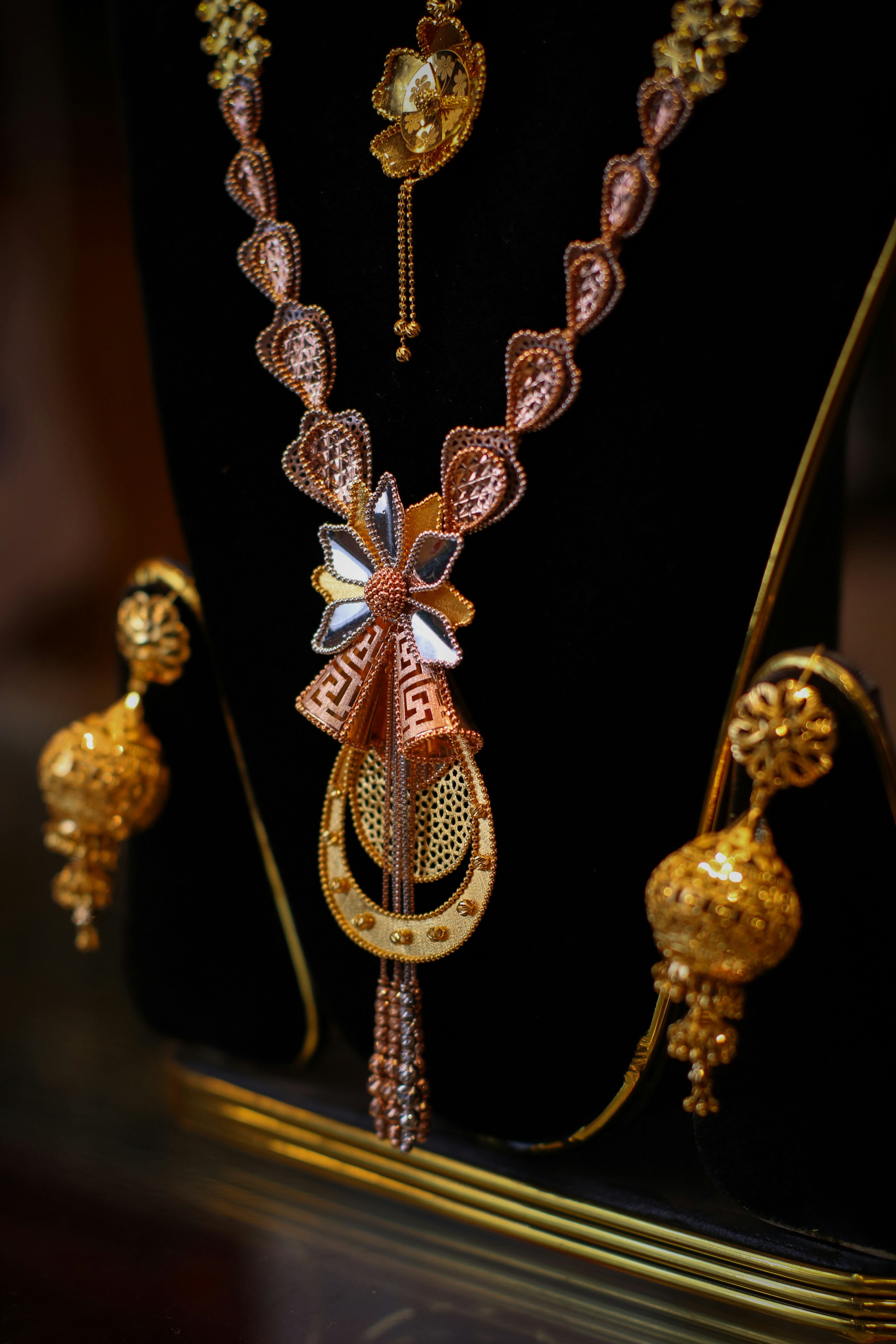 Ornate Pendant on Velvet Backdrop: A Close-Up of Intricate Jewelry Craft
