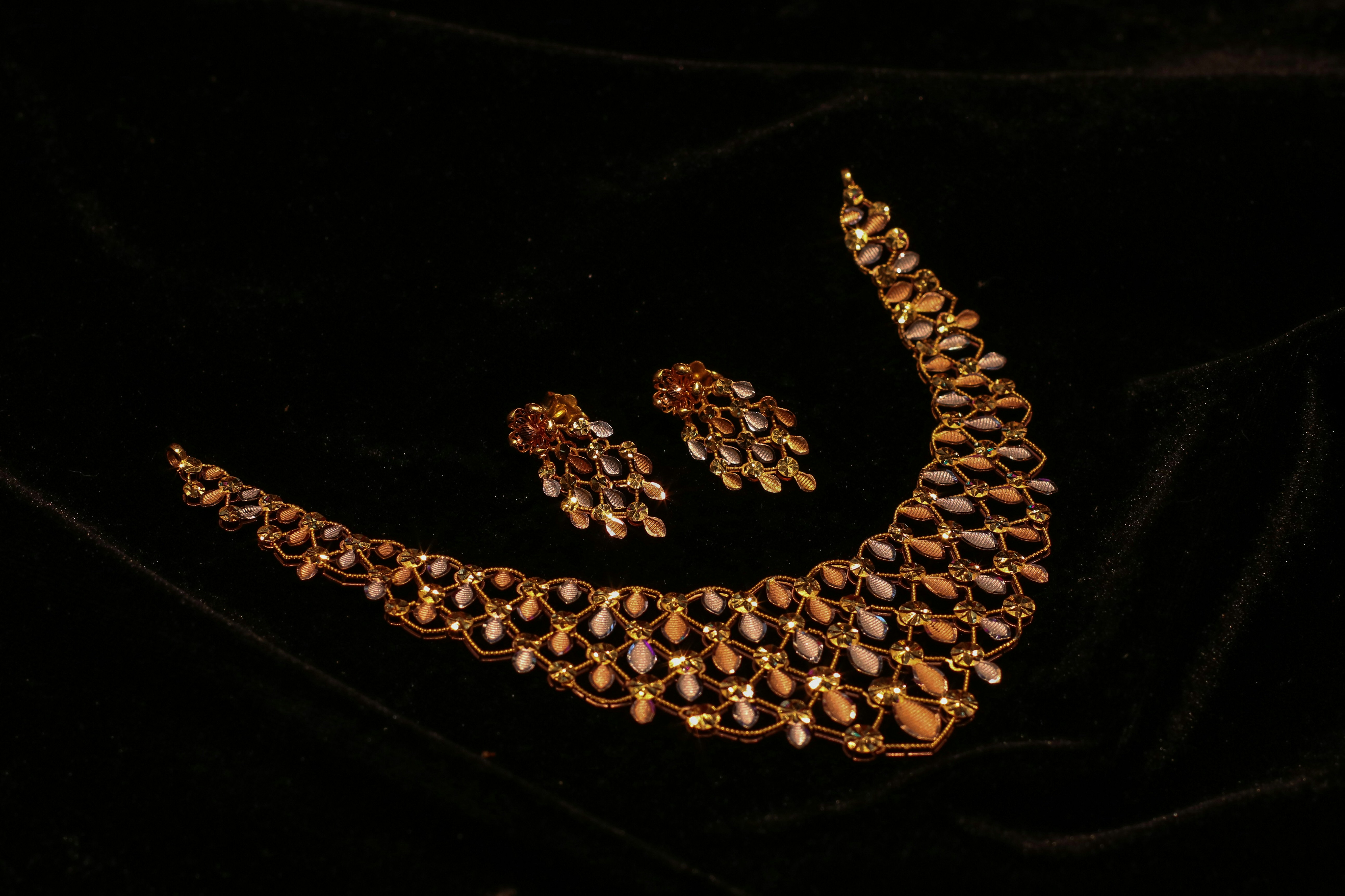 Golden Cascade: Luxurious Necklace and Earrings Reclining on Velvet