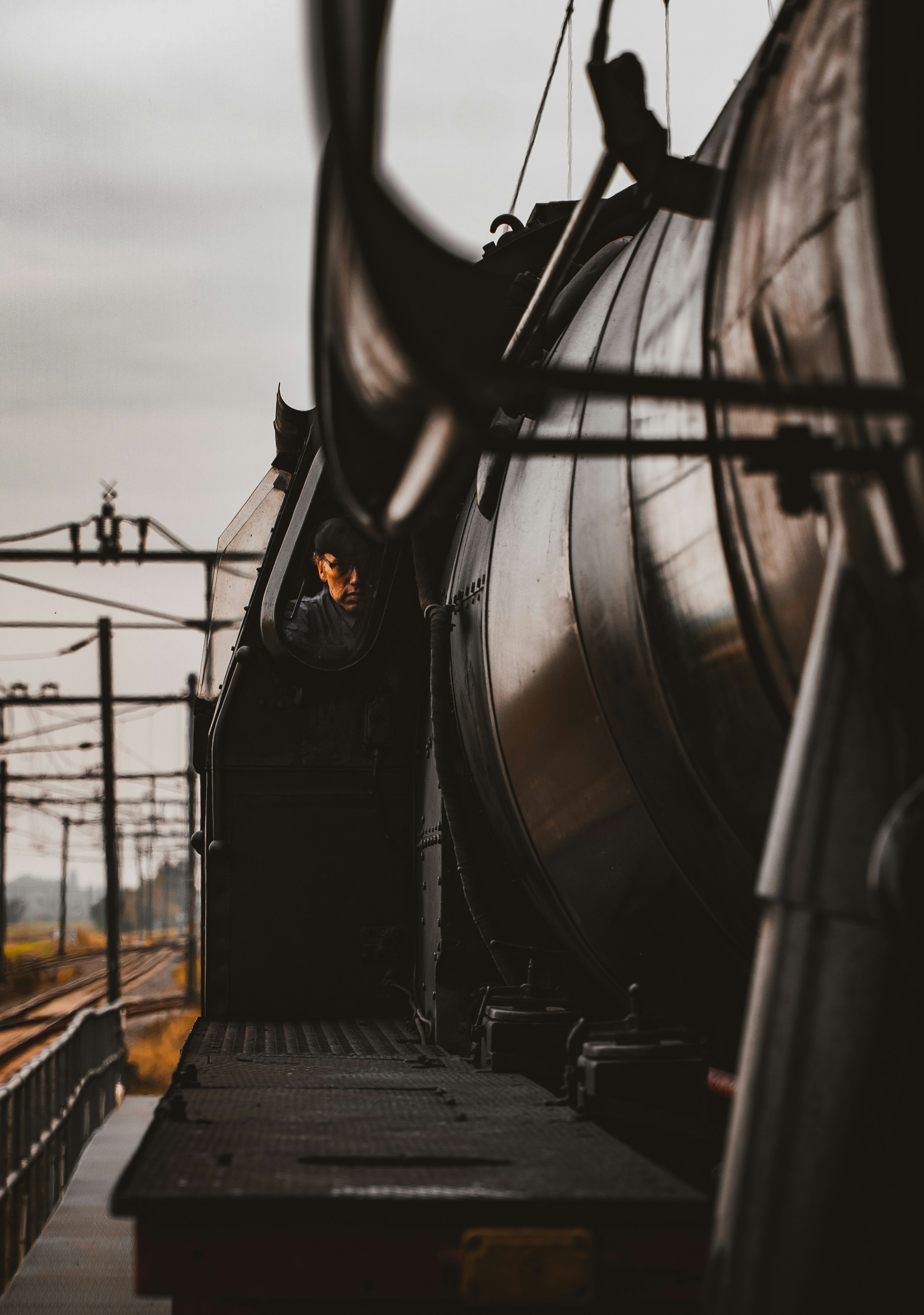 Engine Whisper: A Conductor’s Gaze Amid Steam and Steel