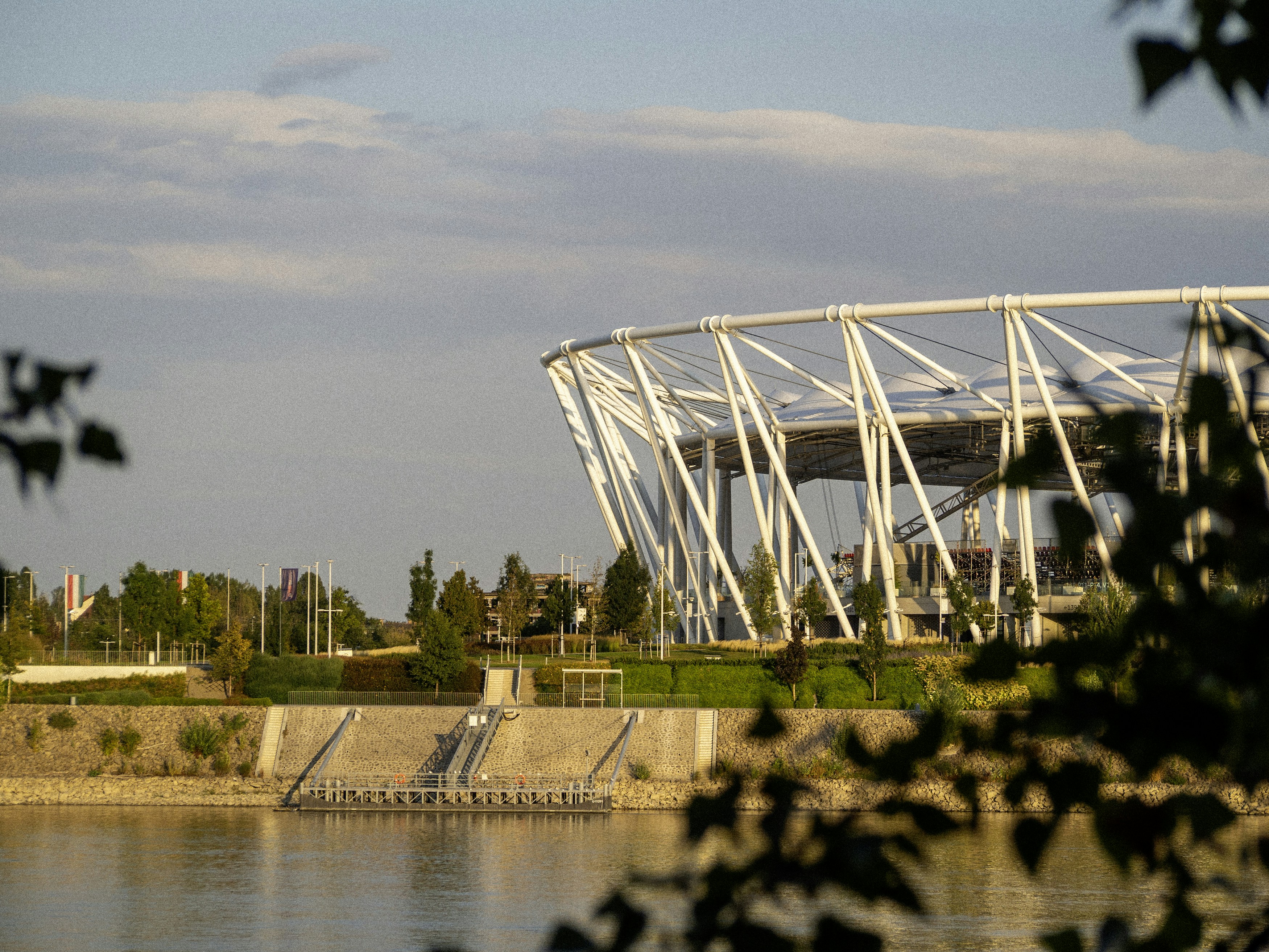Stadium Frame: A Riverside View Framed by Foliage