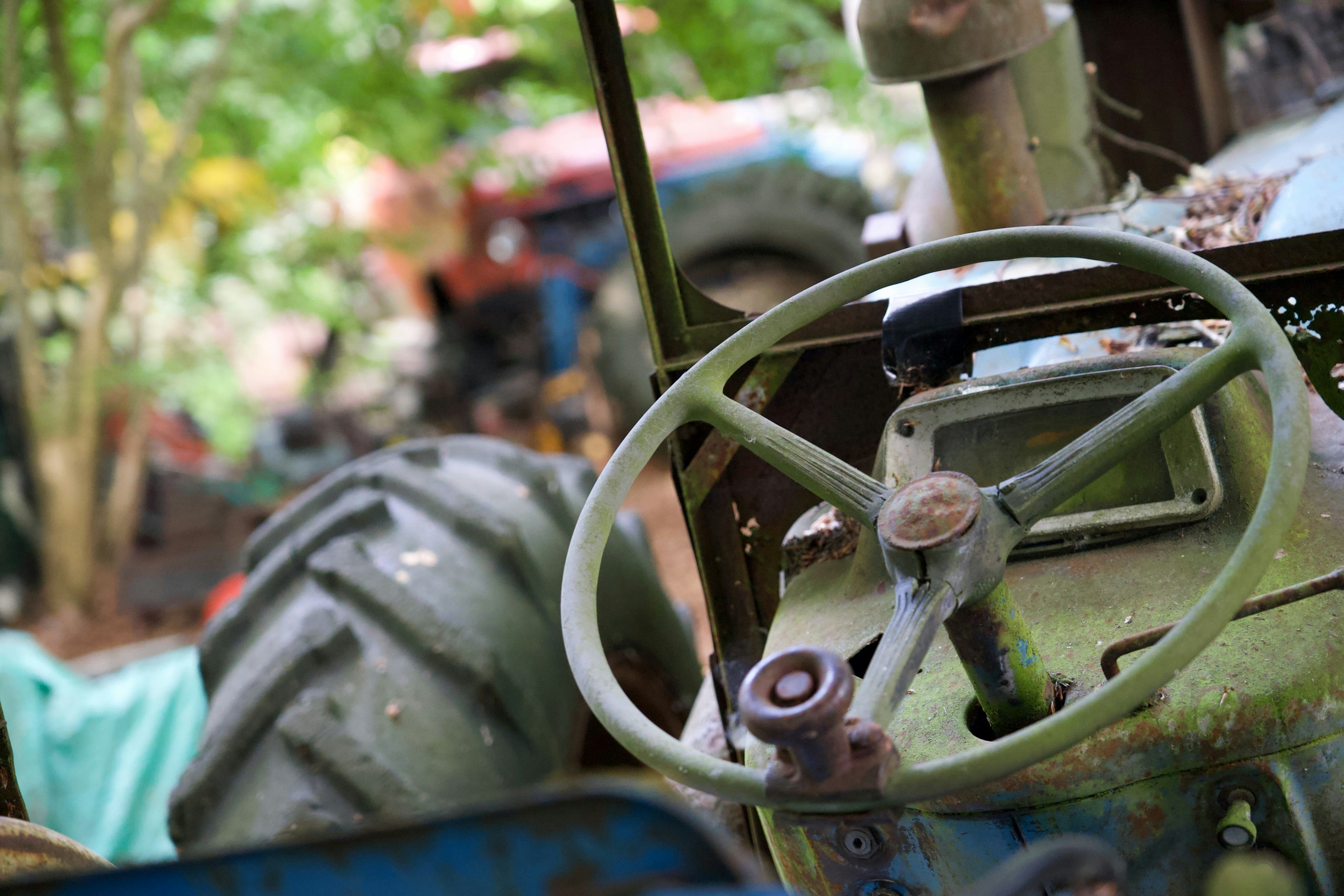 Stormy Green Steering Wheel: A Rusted Tractor’s Quiet Story