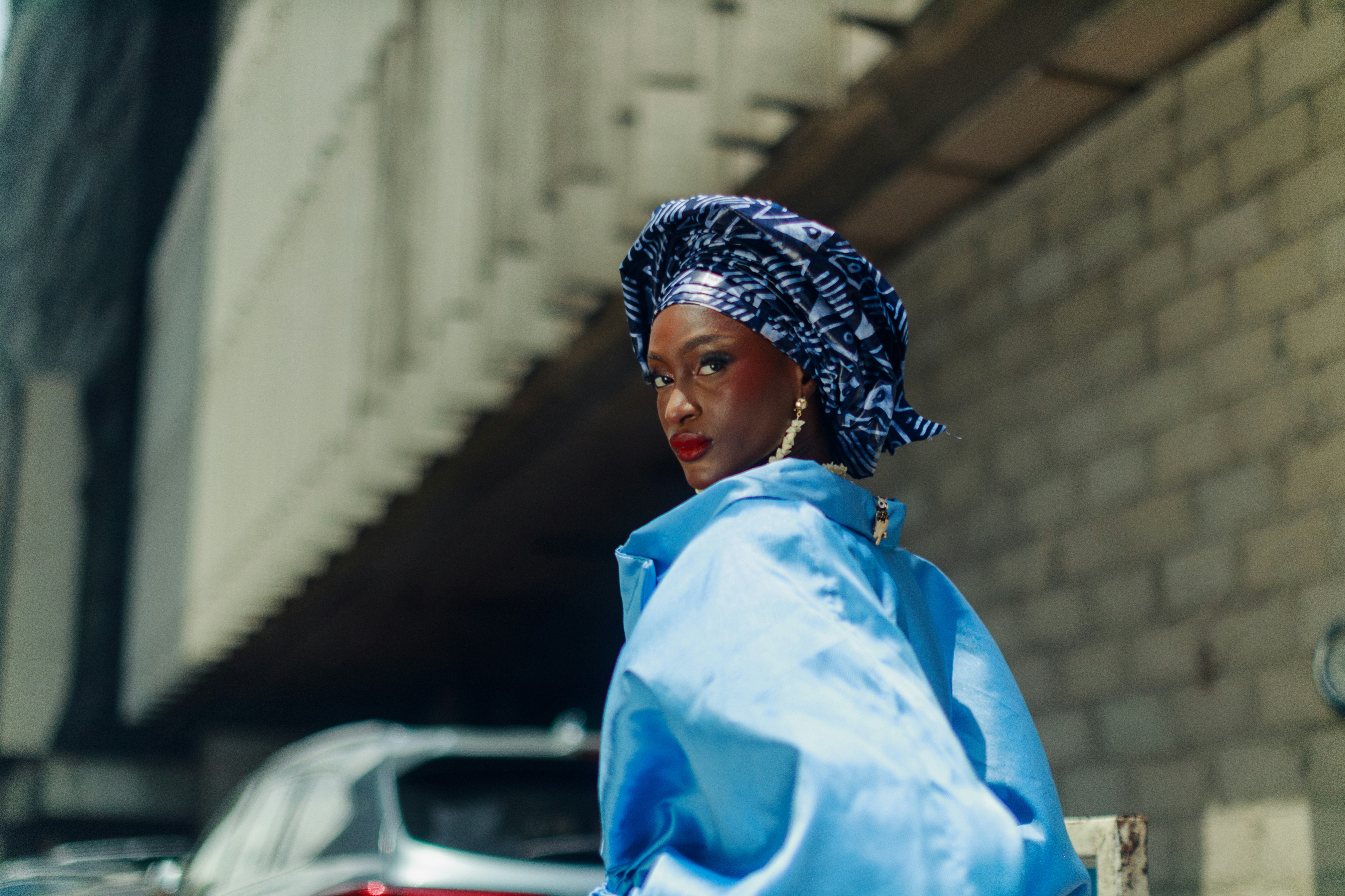 Blue Silk and Bold Headwrap: A Portrait in Urban Light