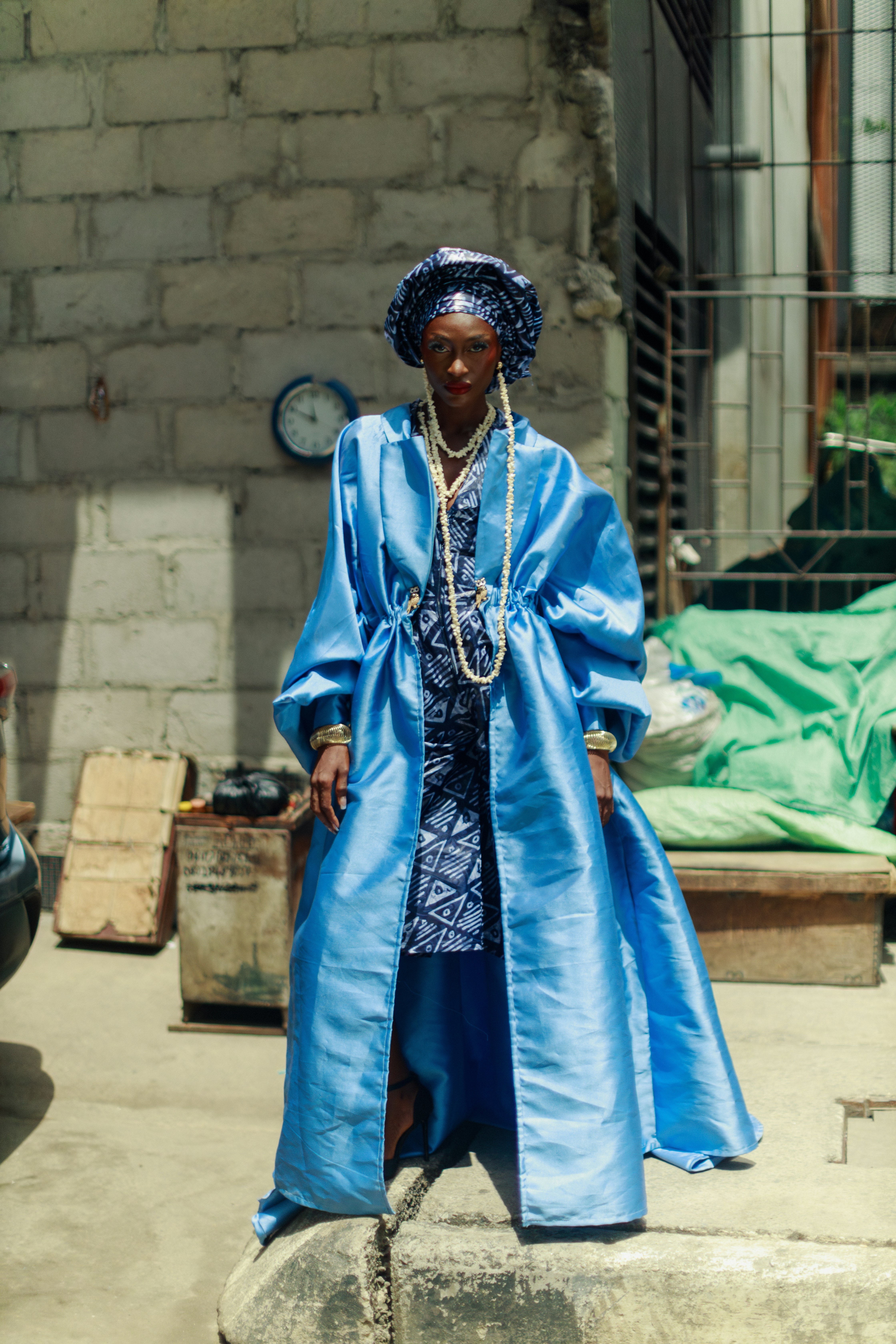 Blue Robed Elegance: A Portrait of Ceremony in the Alley