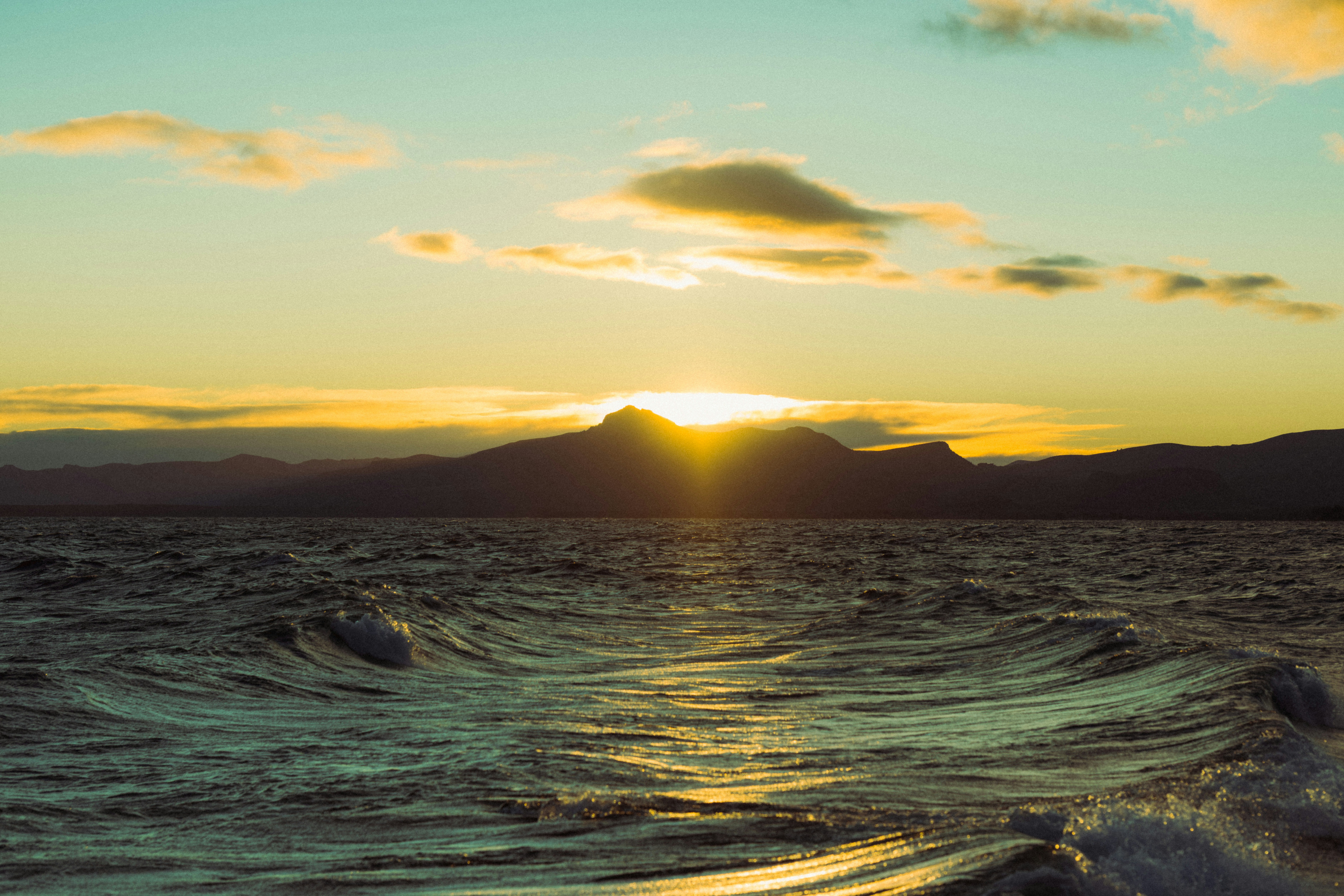 Dawn Over Quiet Seas: The Sun Neatly Drapes the Horizon