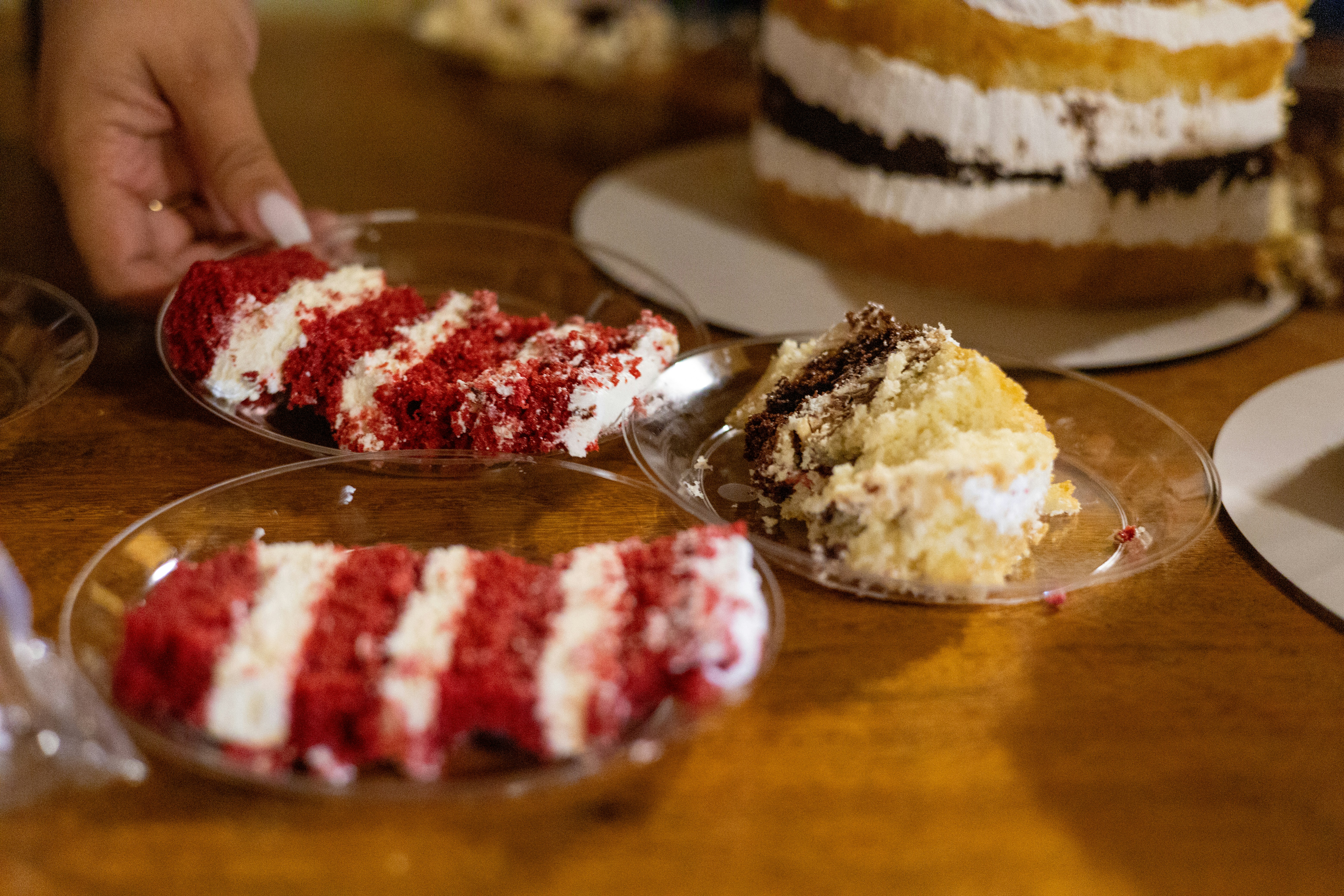 Slices of Red Velvet and Vanilla Cake on a Wooden Table