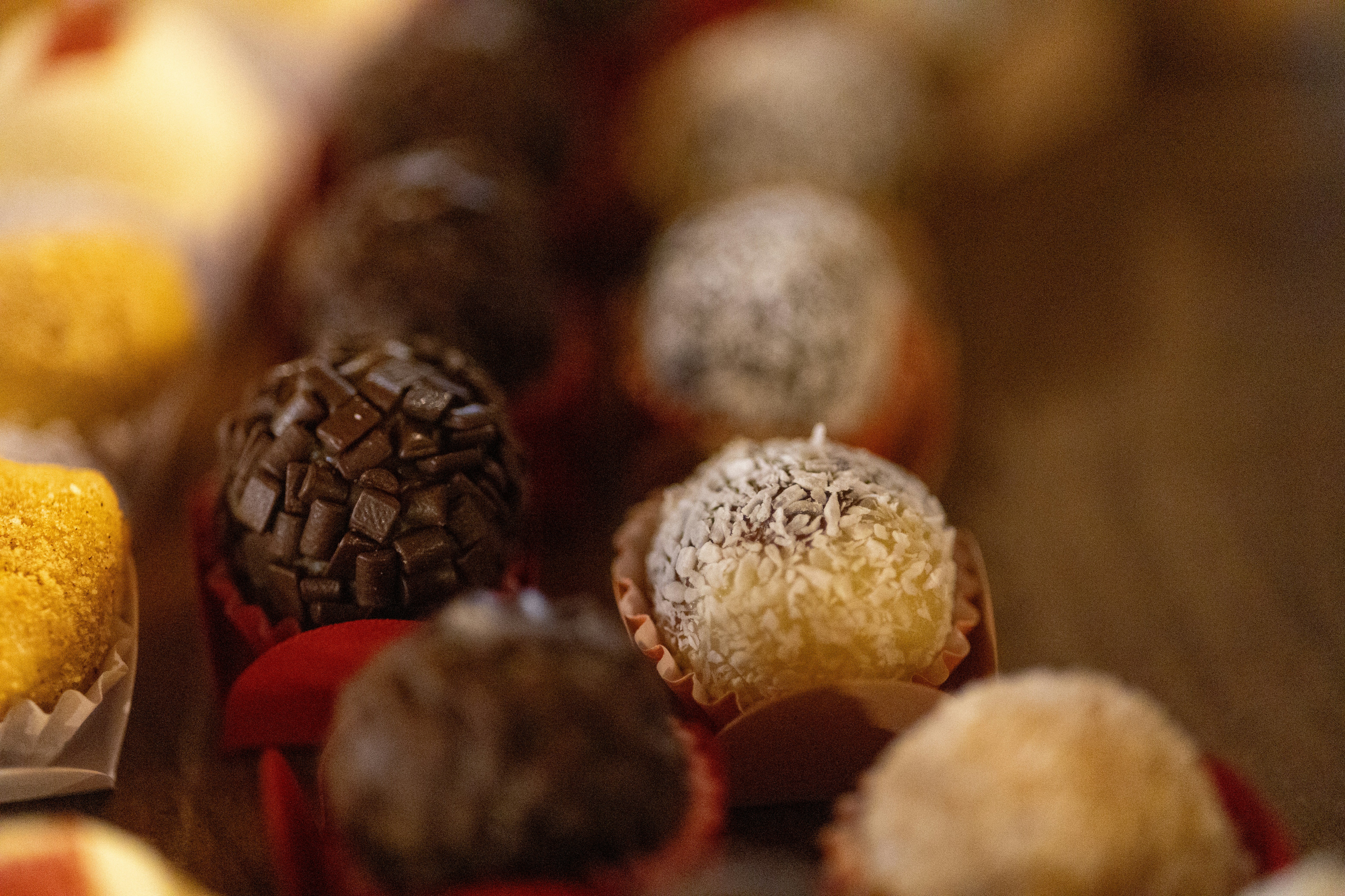 Centered Confections: A Row of Chocolate Truffles on a Wooden Display