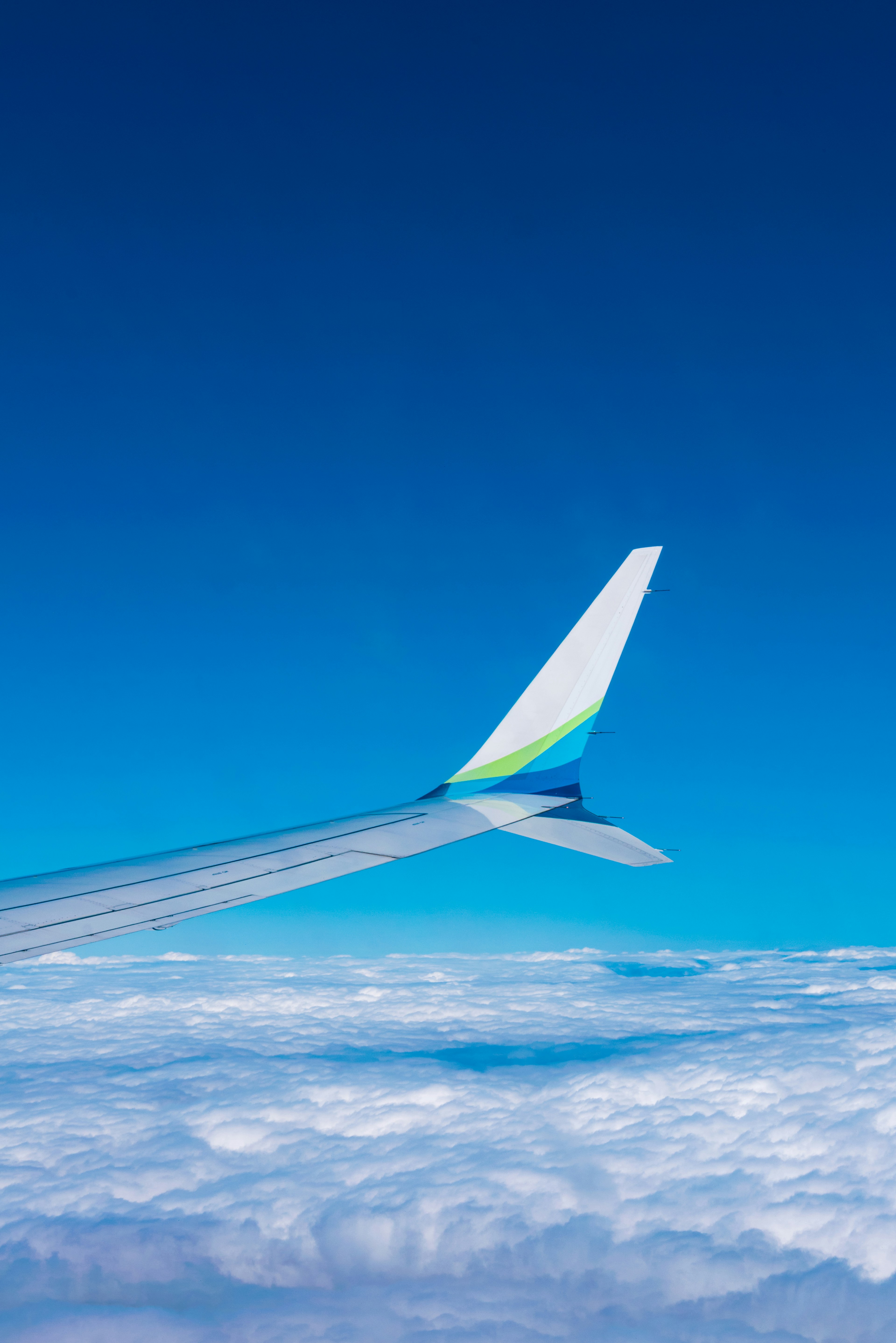 Wingtip Silence: Blue Sky Beneath a Distant Wing
