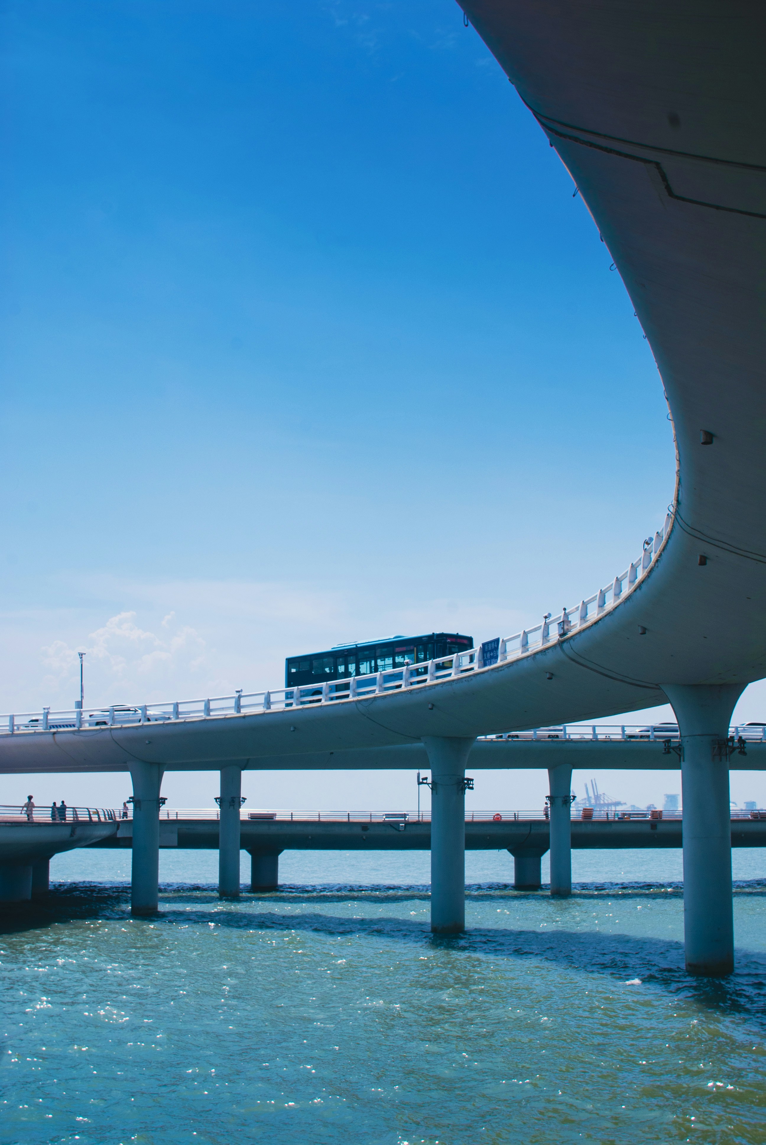 Curved Ocean Bridge: A Silhouette Above Tides
