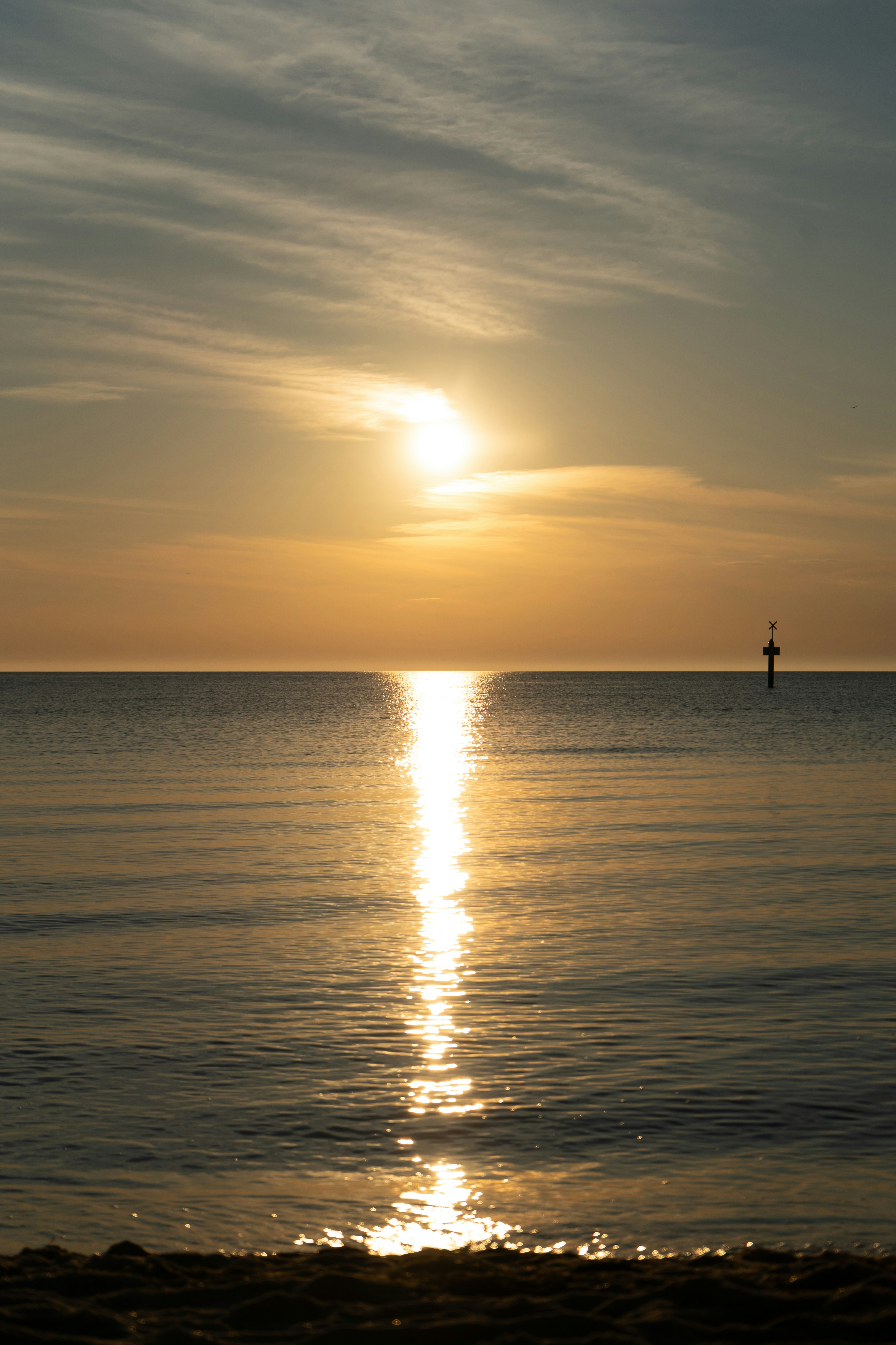 Sunlit Horizon: A Calm Sea Reflects a Quiet Sunset