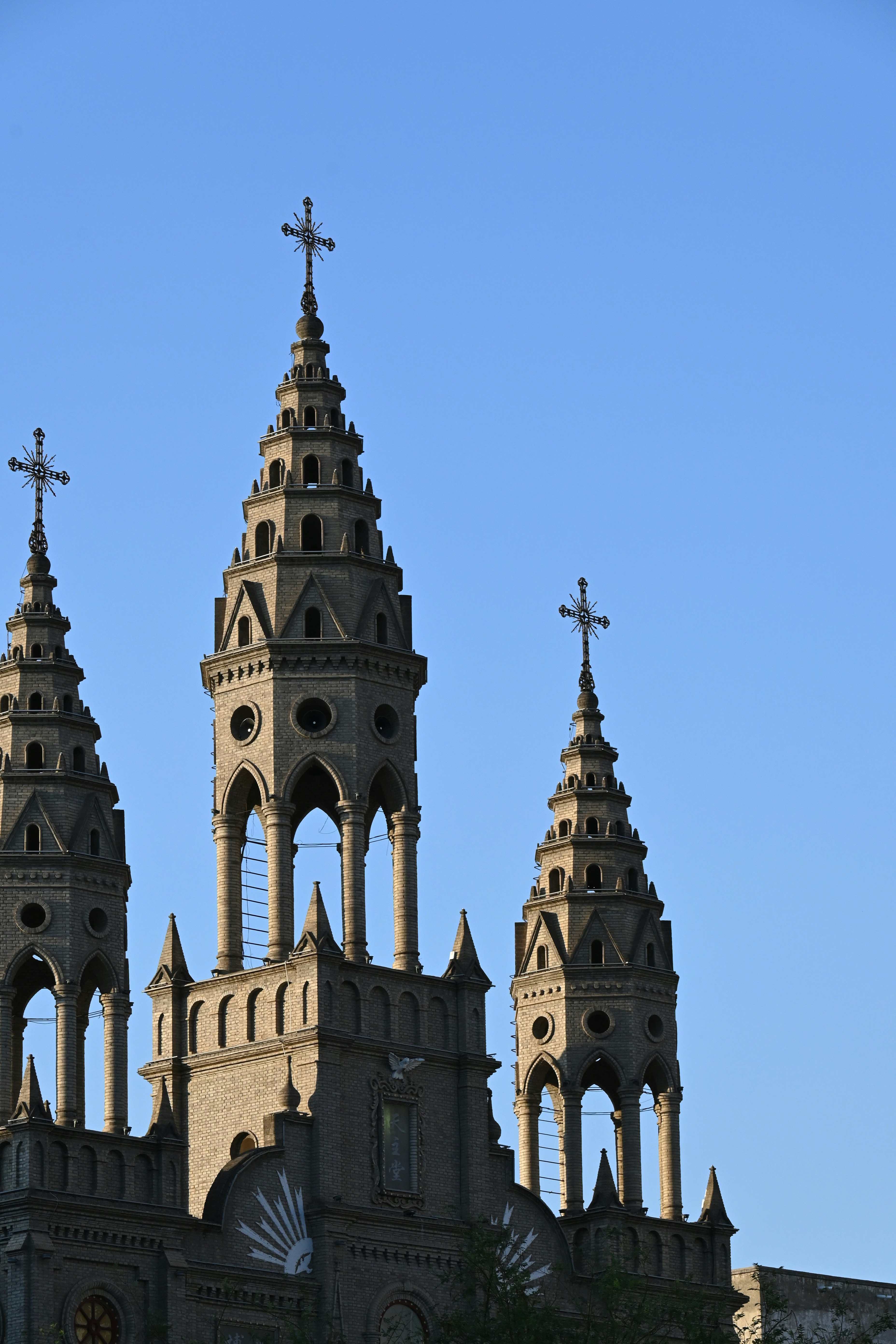 Three-Spired Cathedral Silhouettes Against a Clear Azure Sky