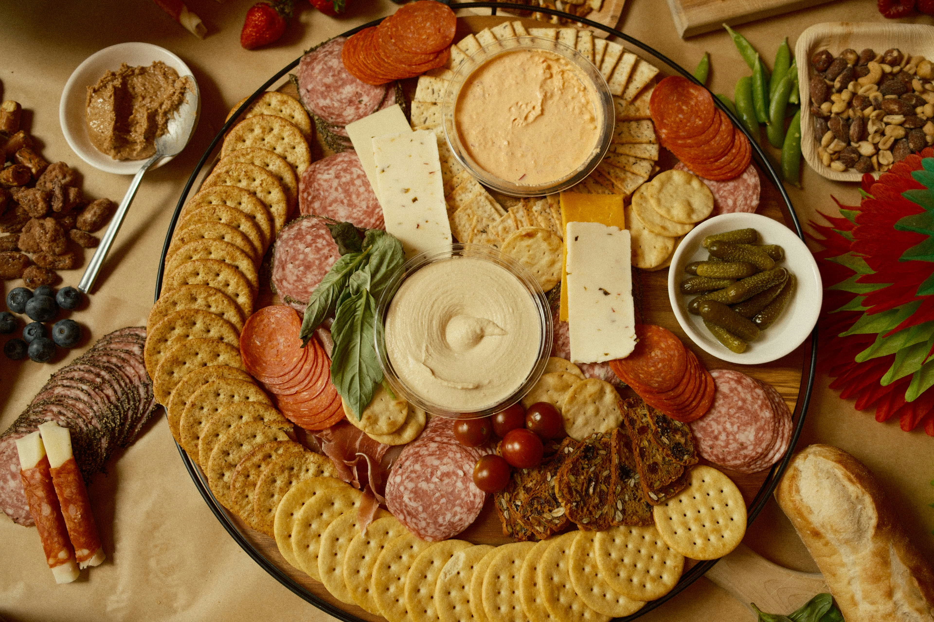 Savory Carousel: A Rich Charcuterie Spread Framed by Citrus and Herb Foliage