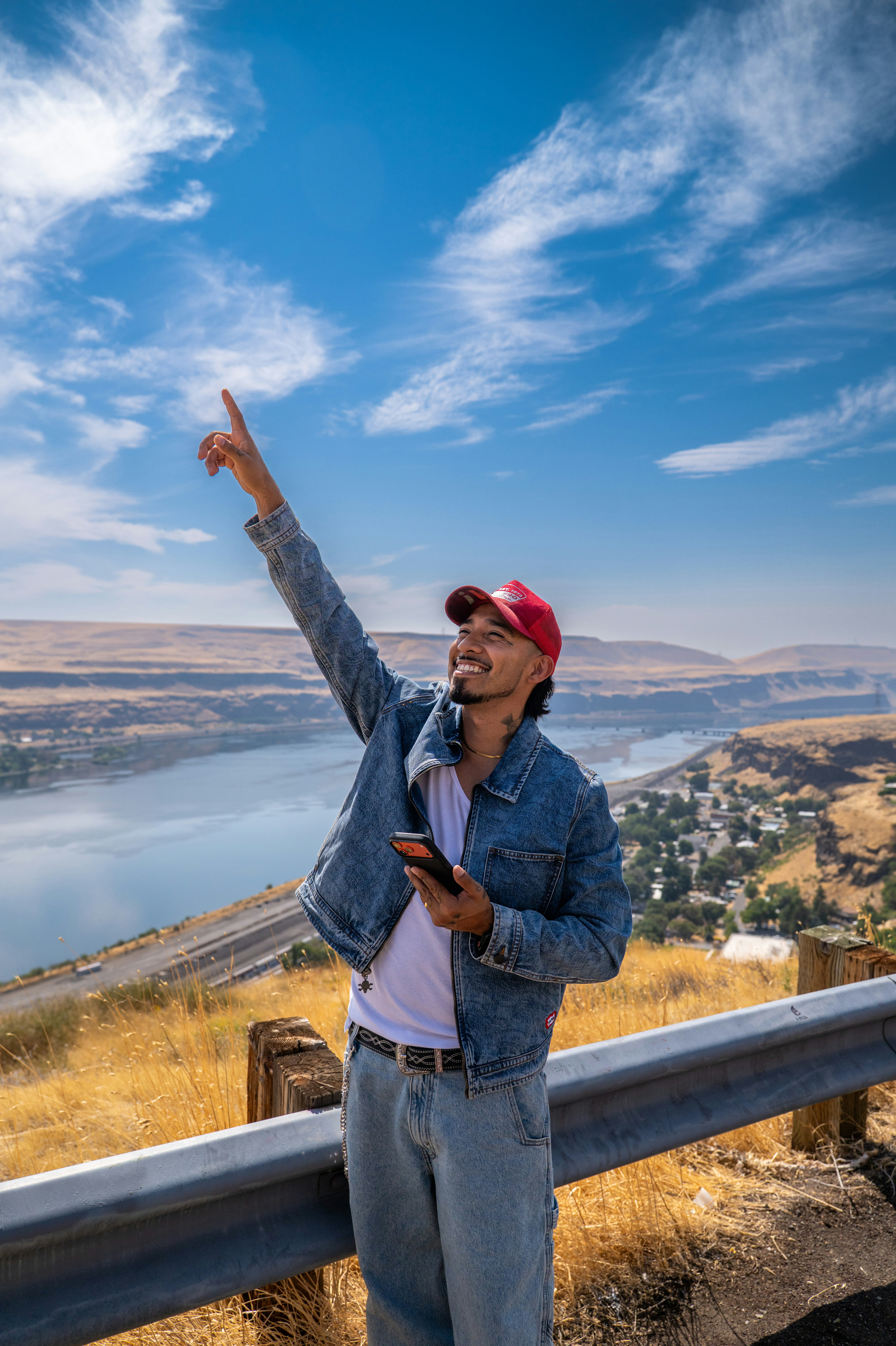 High-Elevation High-Fives: A Traveler Celebrates Over a Valley