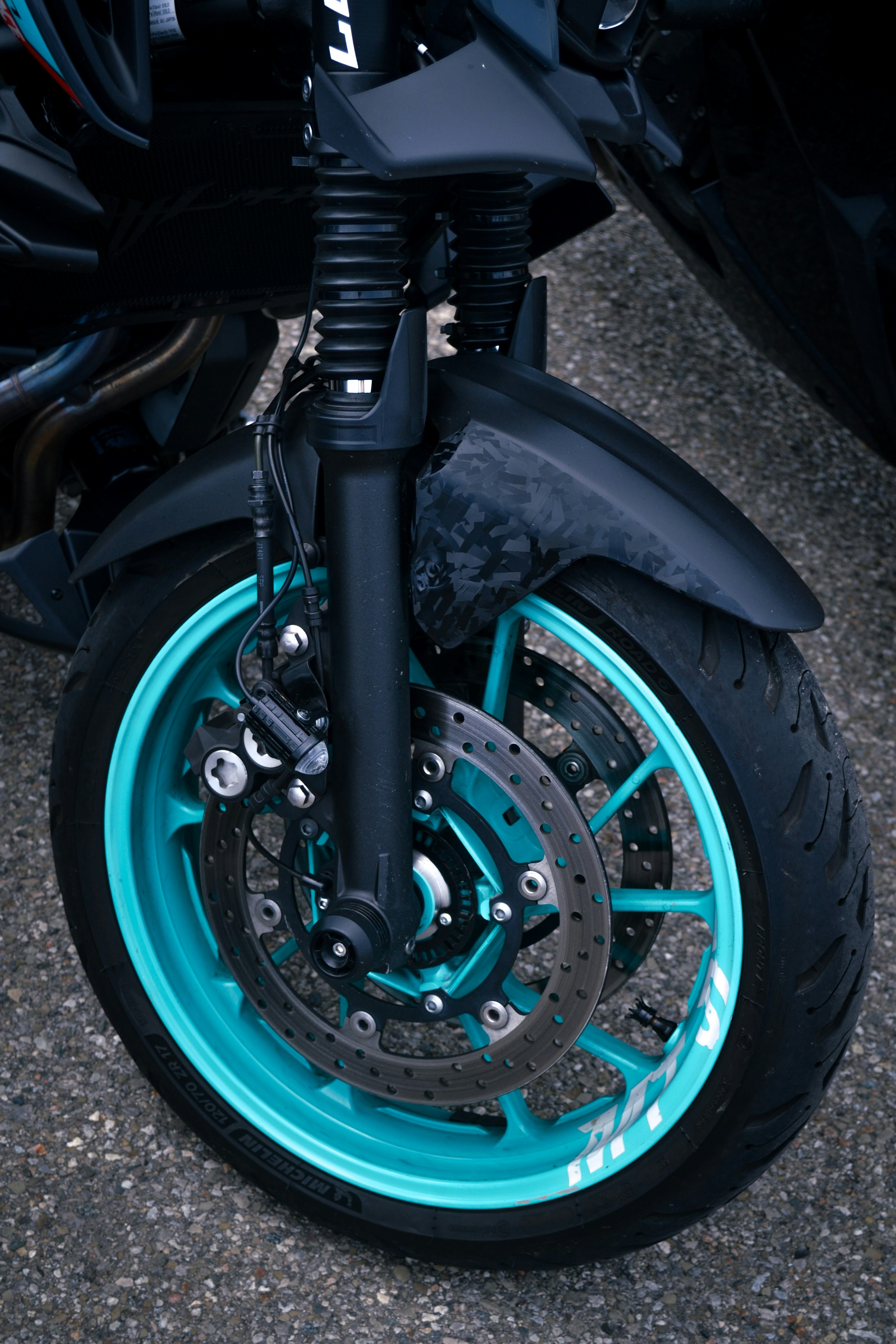 Turquoise Wheel: A Close-Crop of a Modern Motorcycle Front
