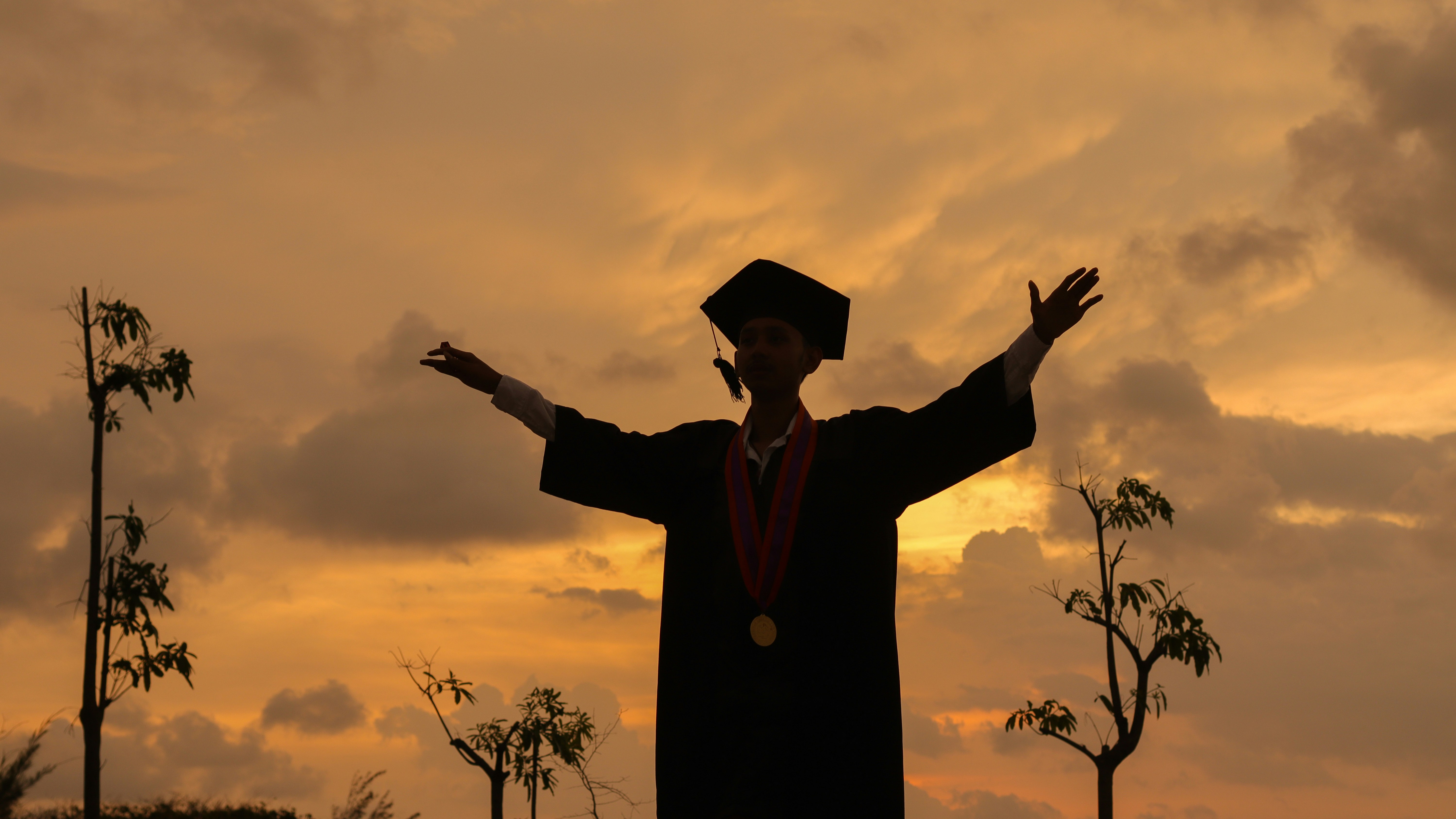 Silhouette of Triumph: Graduation Silhouette Against a Sunset Sky