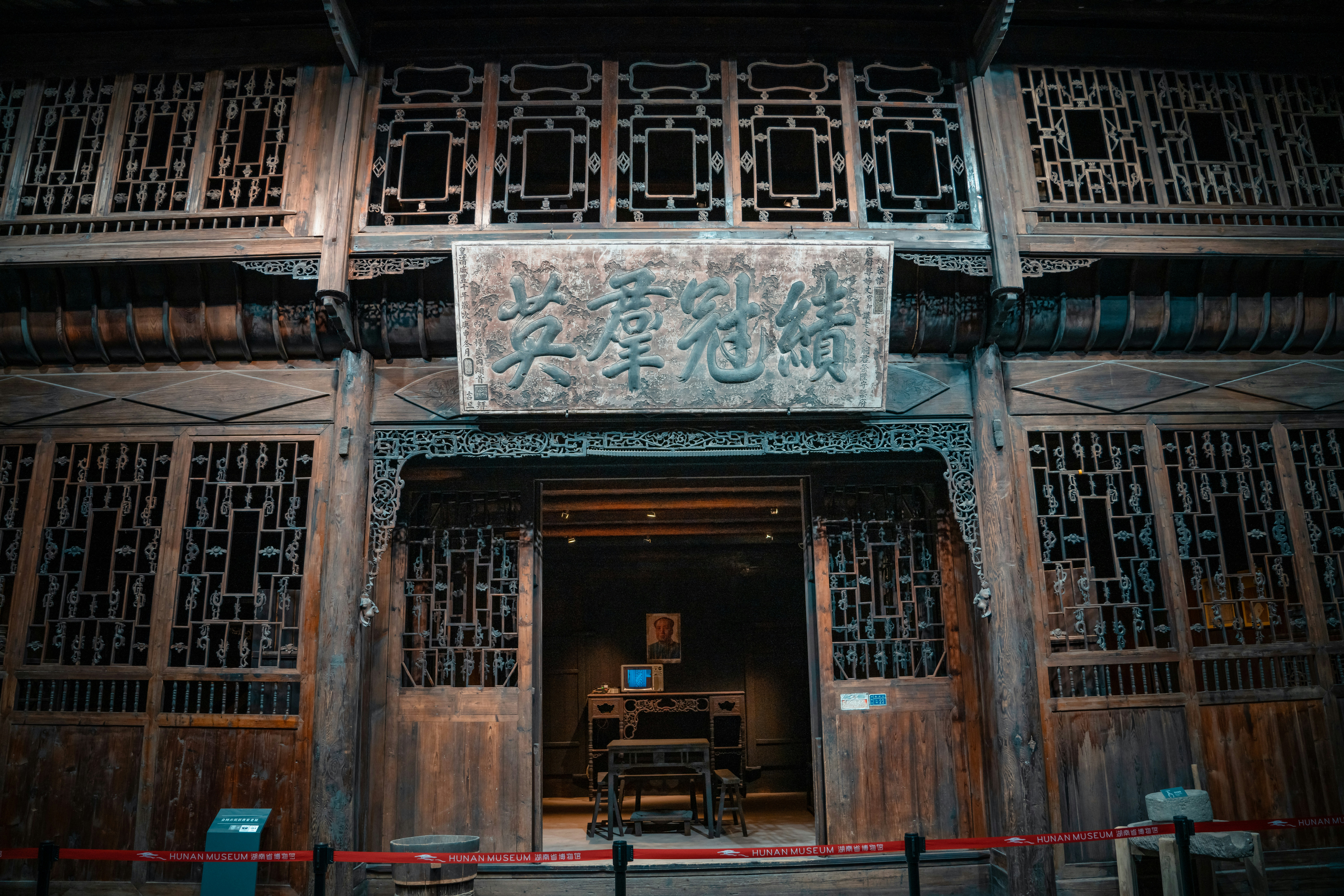 Wooden Temple Façade with Titled Sign and Open Door