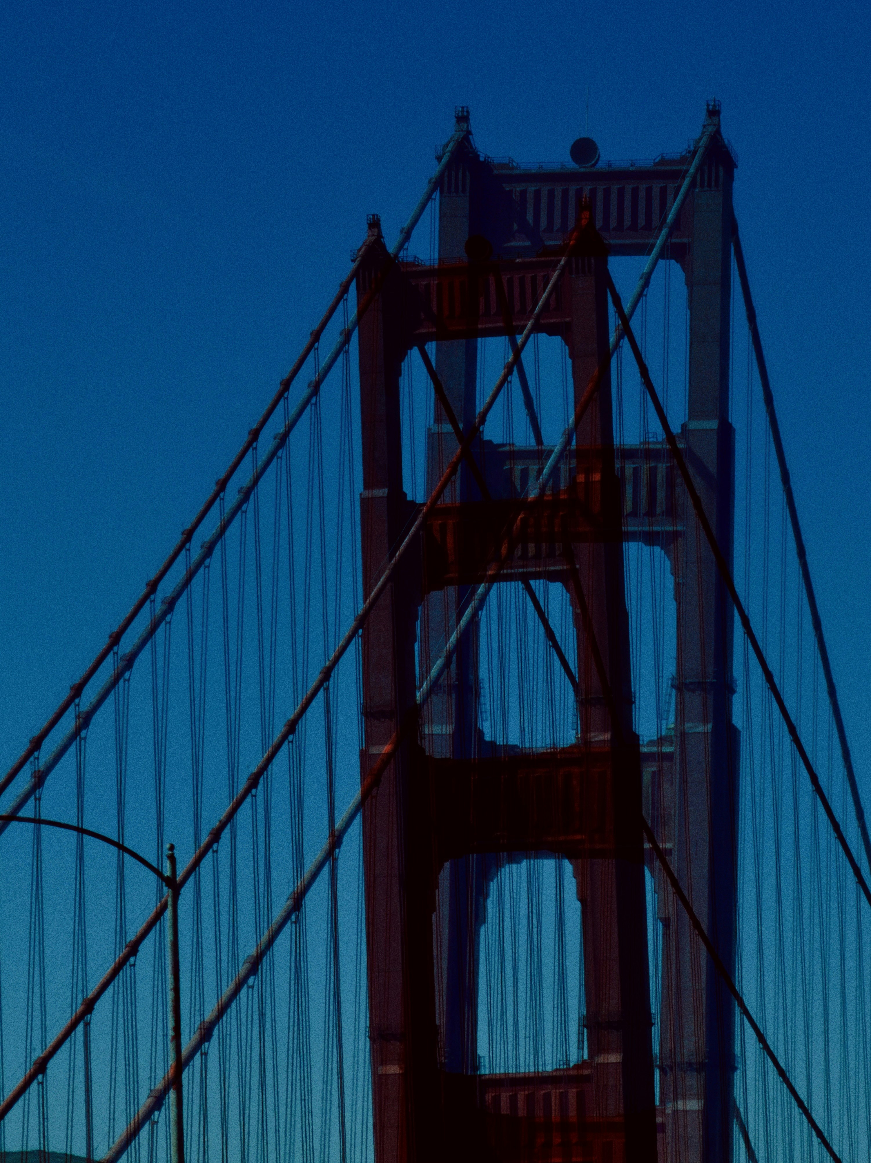 Towering Blue Hour: The Red Suspension Frame Against a Velvet Sky