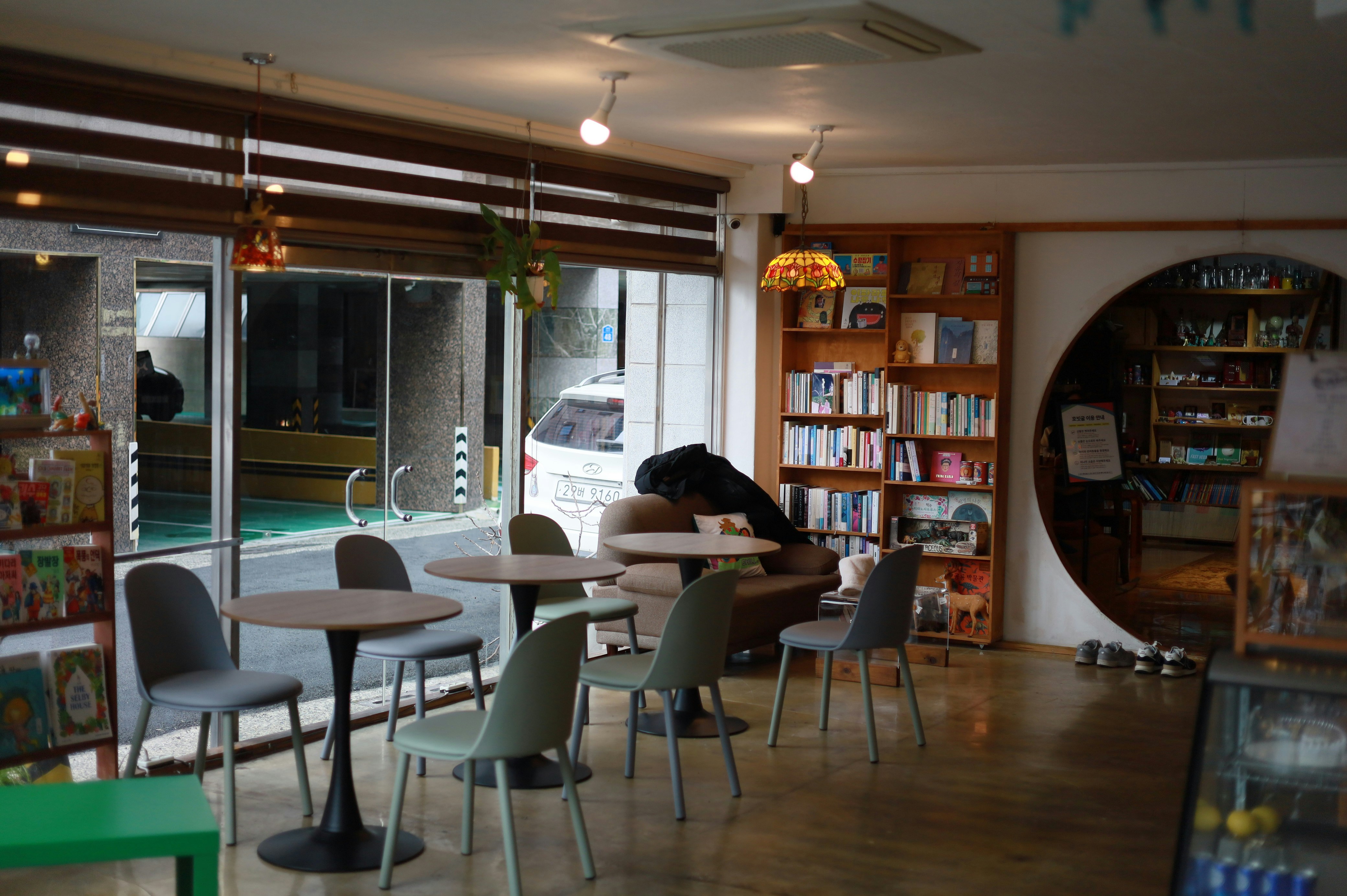 Quiet Library Café Scene with Reader at a Round Table