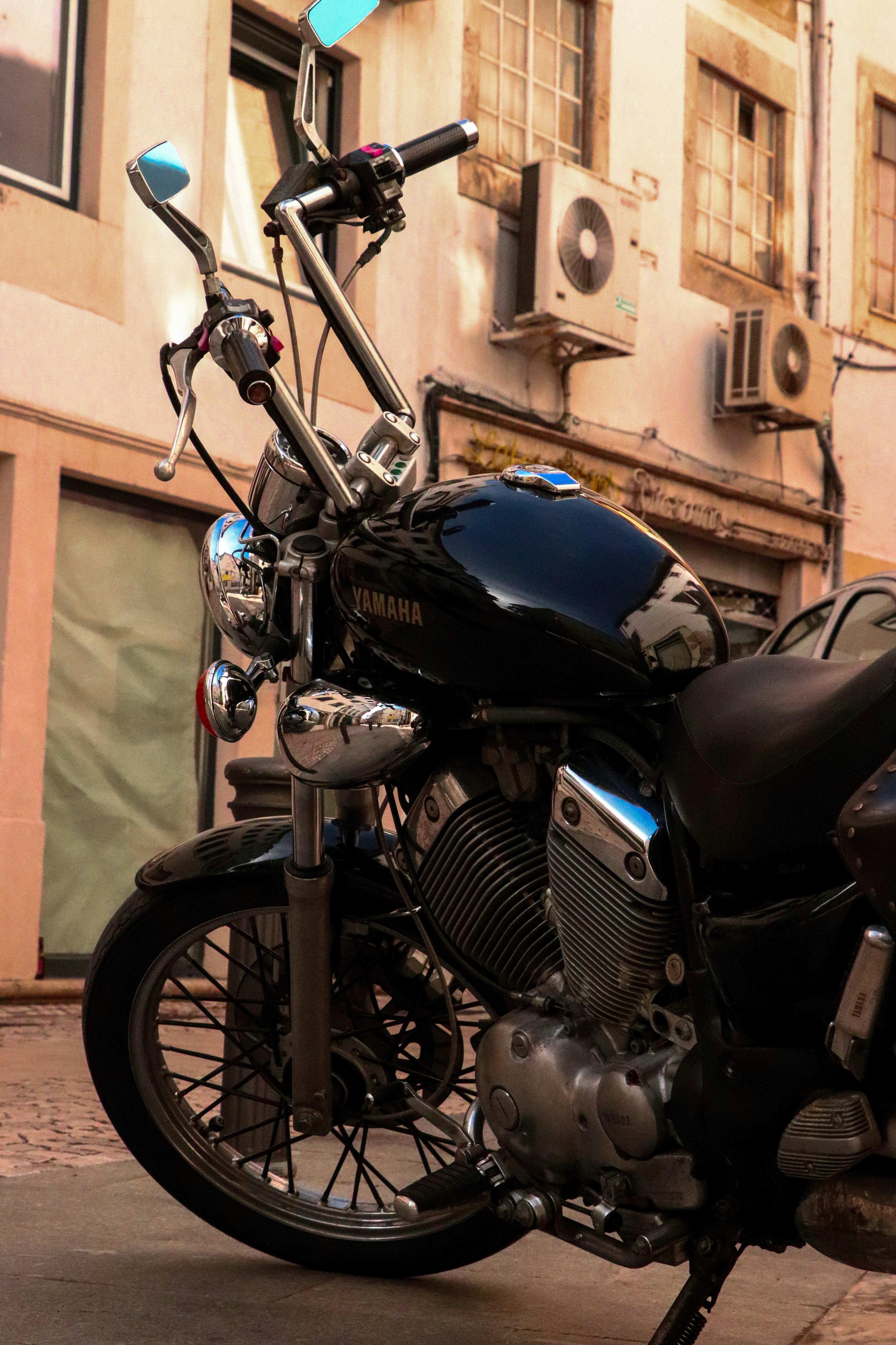 Black Yamaha at the Corner: Chrome and Warm Brick Auras